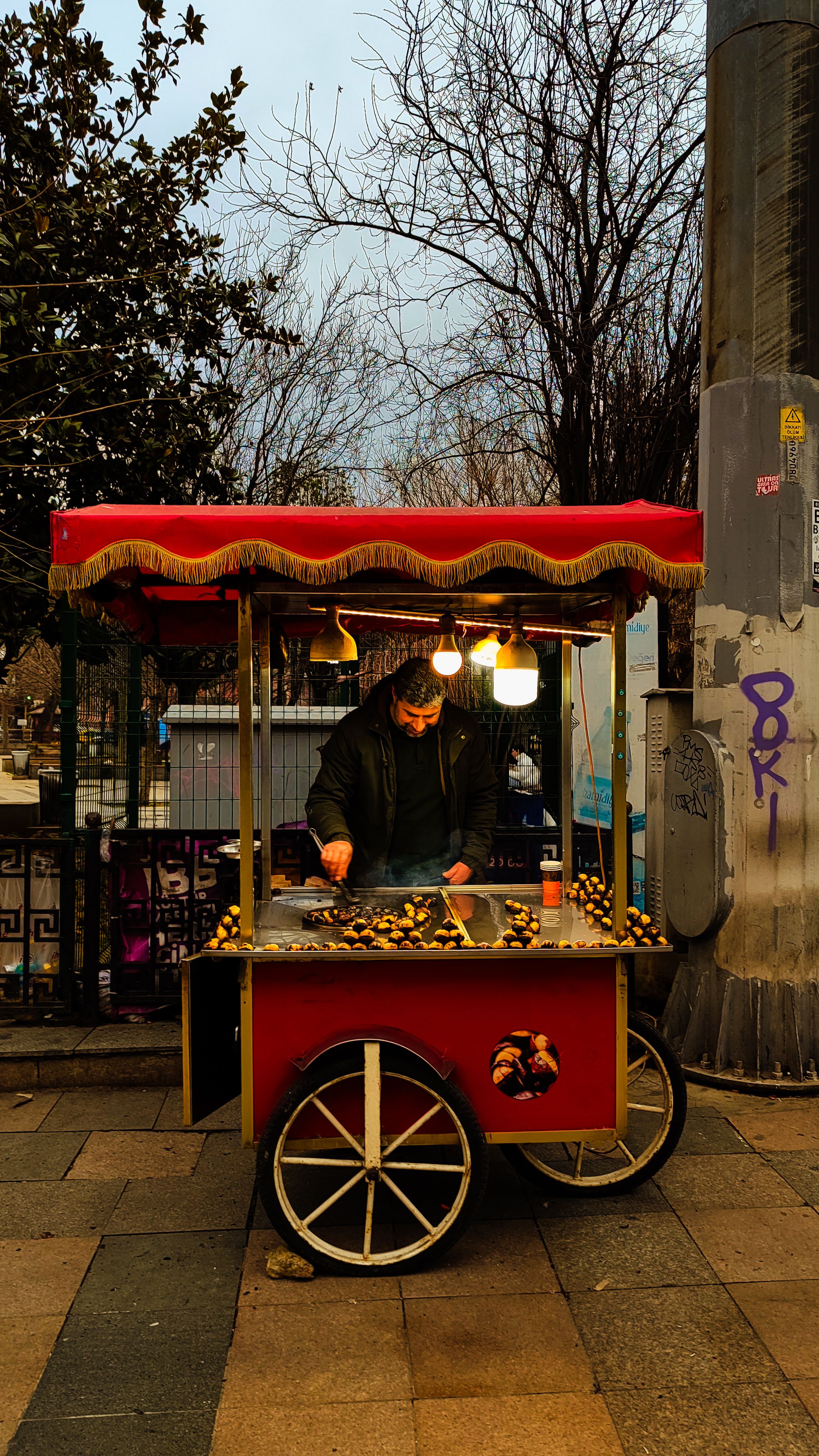 A Man Selling Food from a Food Cart on a Street in City · Free Stock Photo