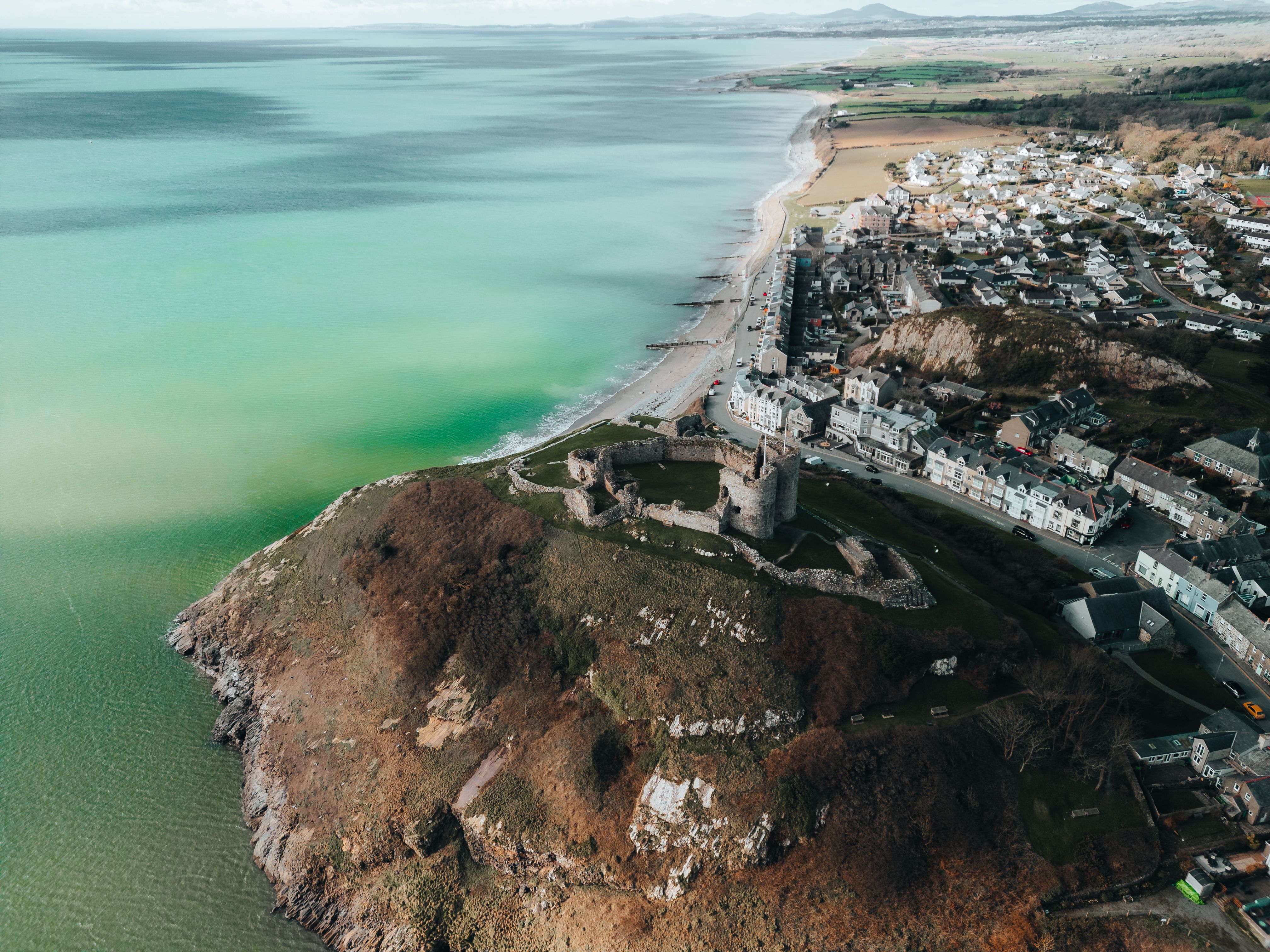 Aerial Footage of a Coastal Town with a Castle · Free Stock Photo