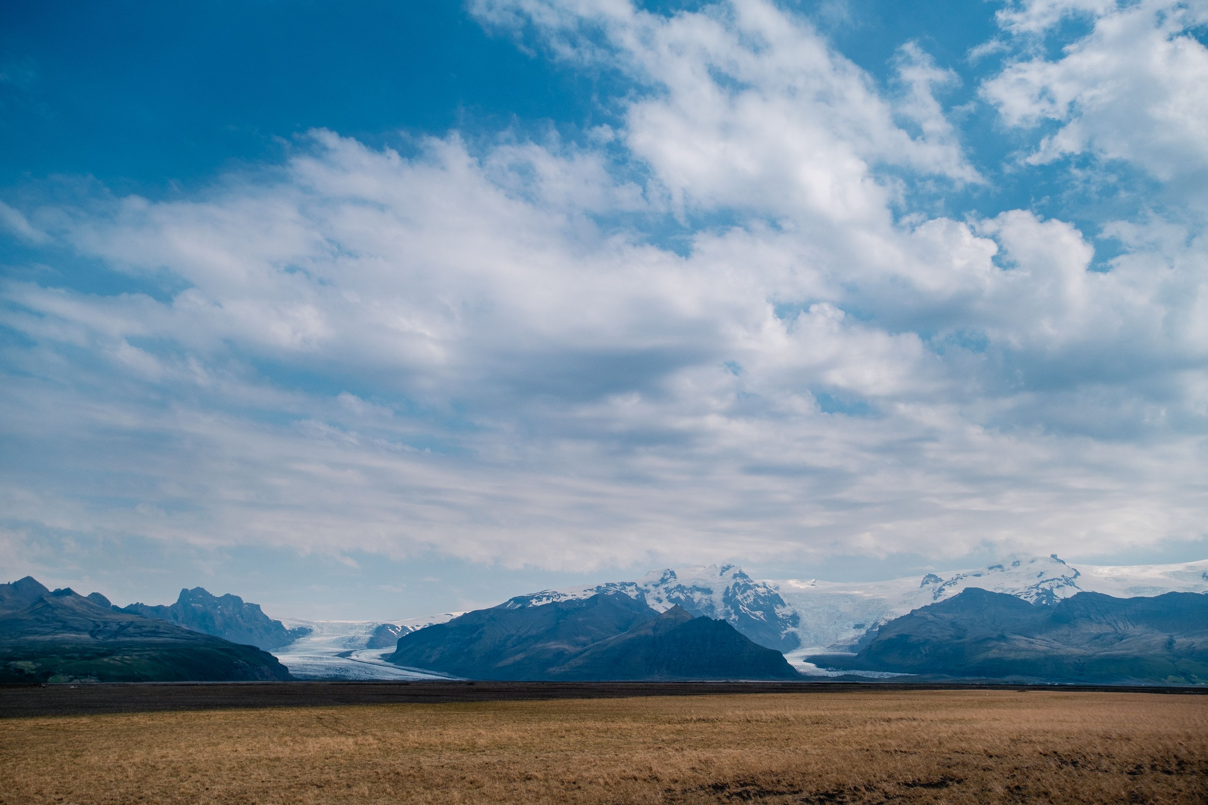 Lowland with Mountains On the Horizon · Free Stock Photo