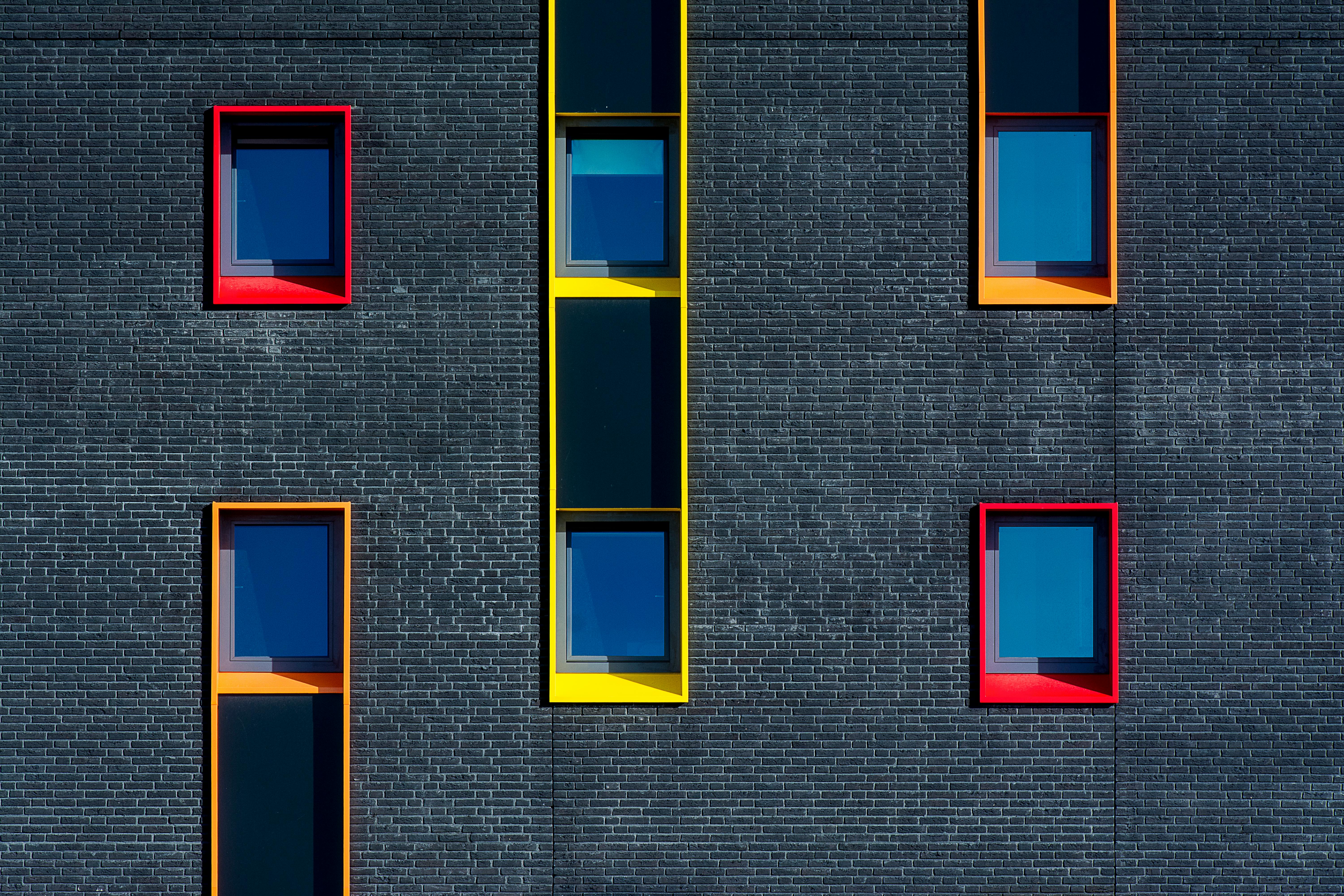 Gray Building Wall with Colorful Windows · Free Stock Photo