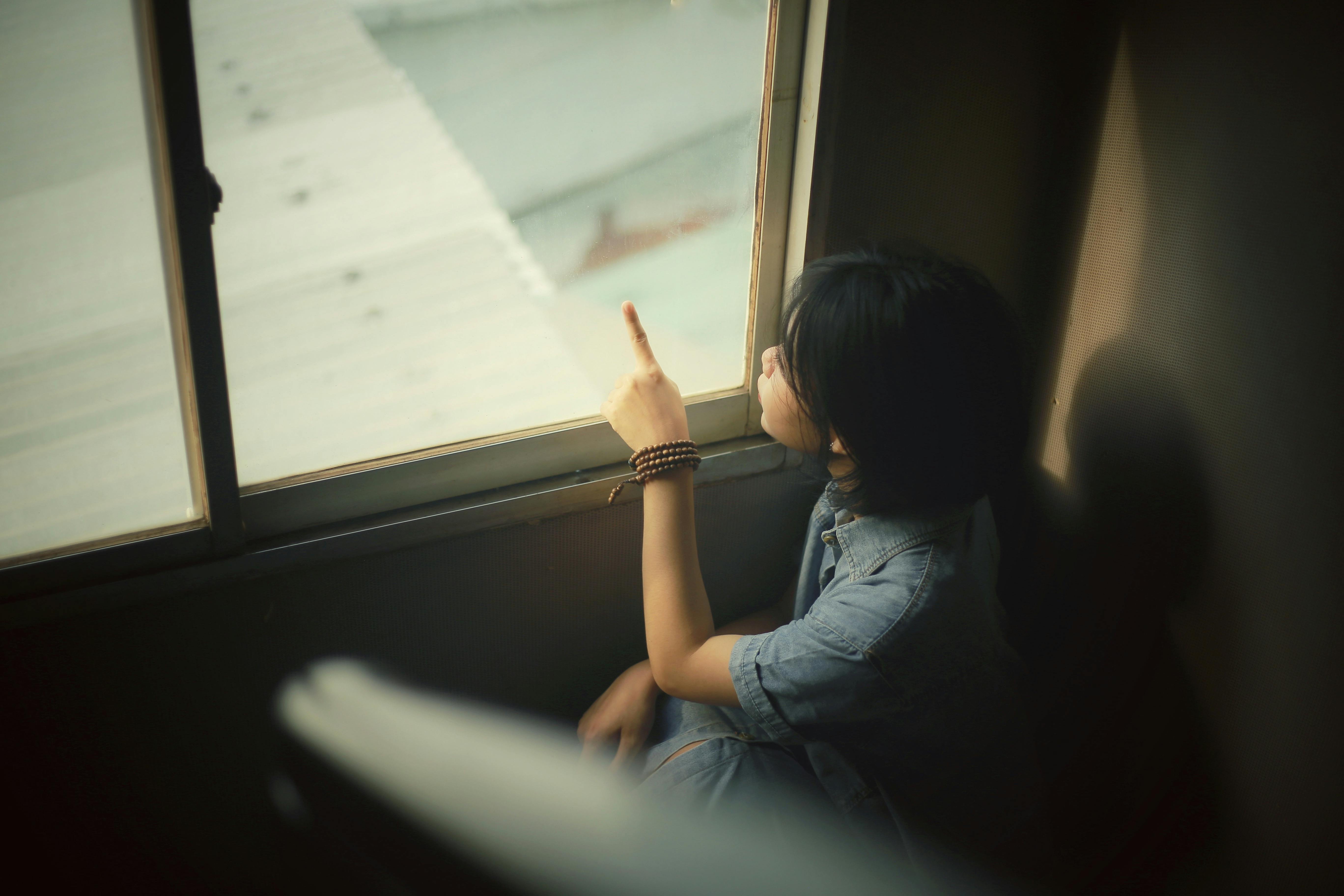 Kid Pointing at a Window · Free Stock Photo