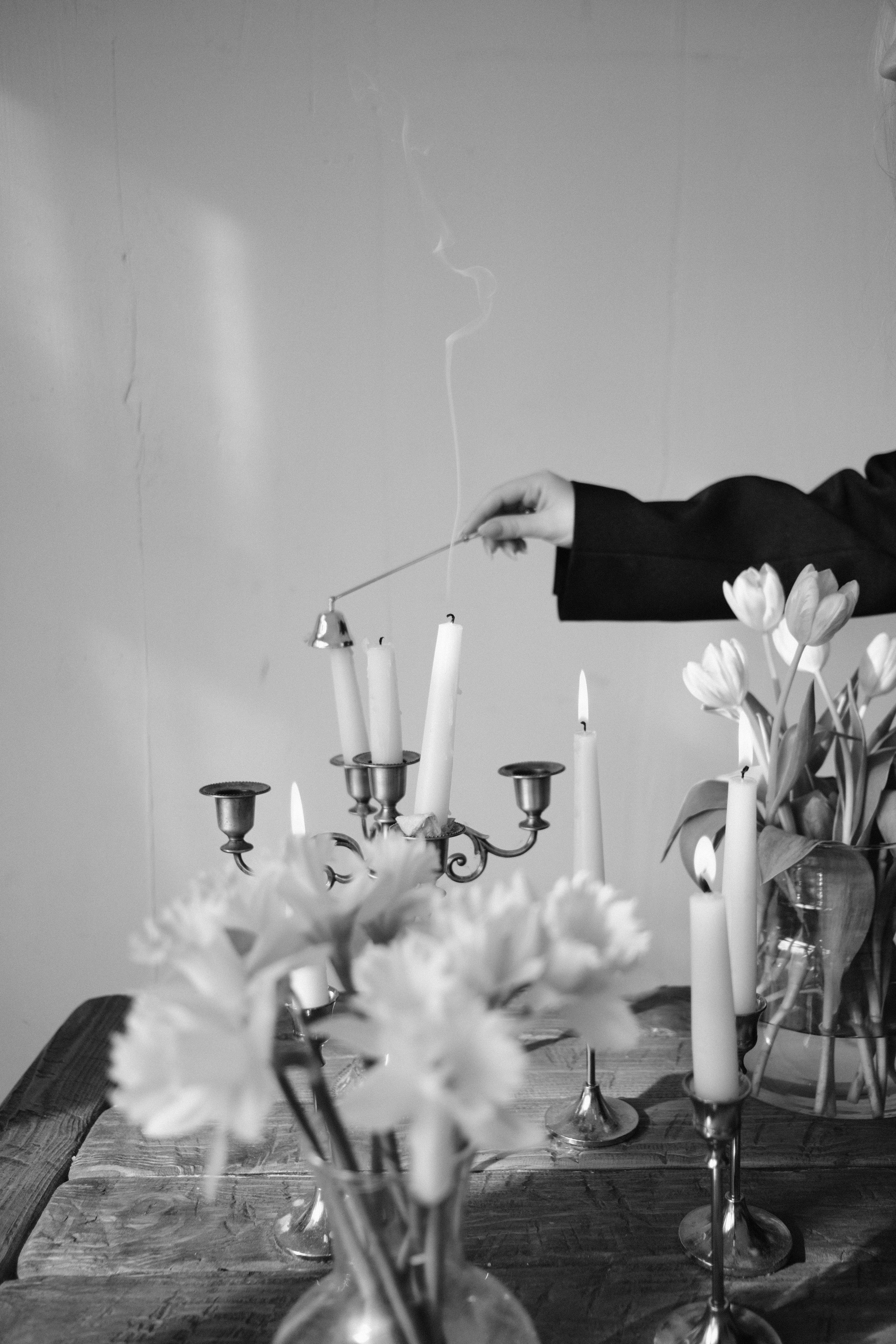 A Person Holding a Candle Snuffer · Free Stock Photo