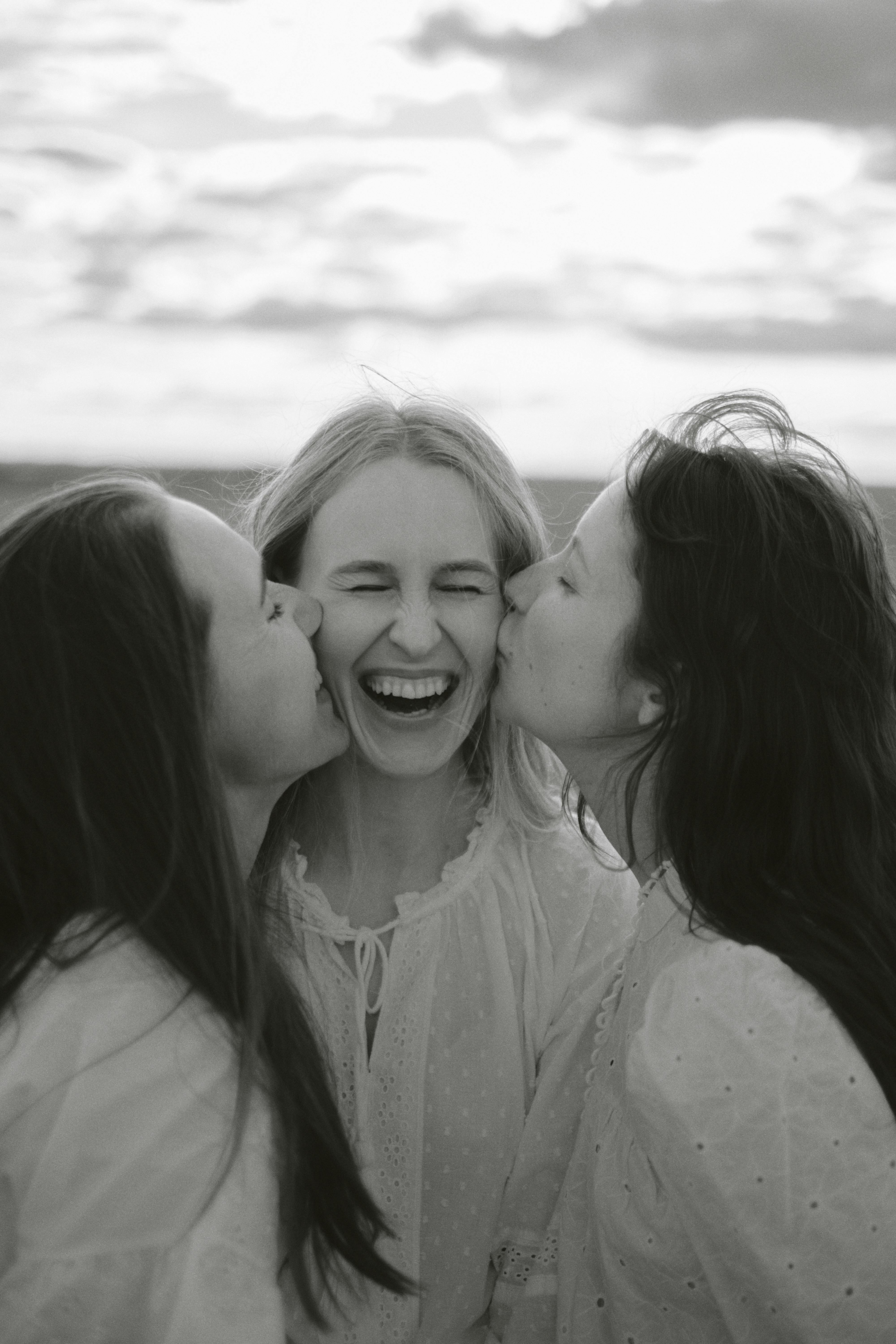 Smiling Women Kissing · Free Stock Photo