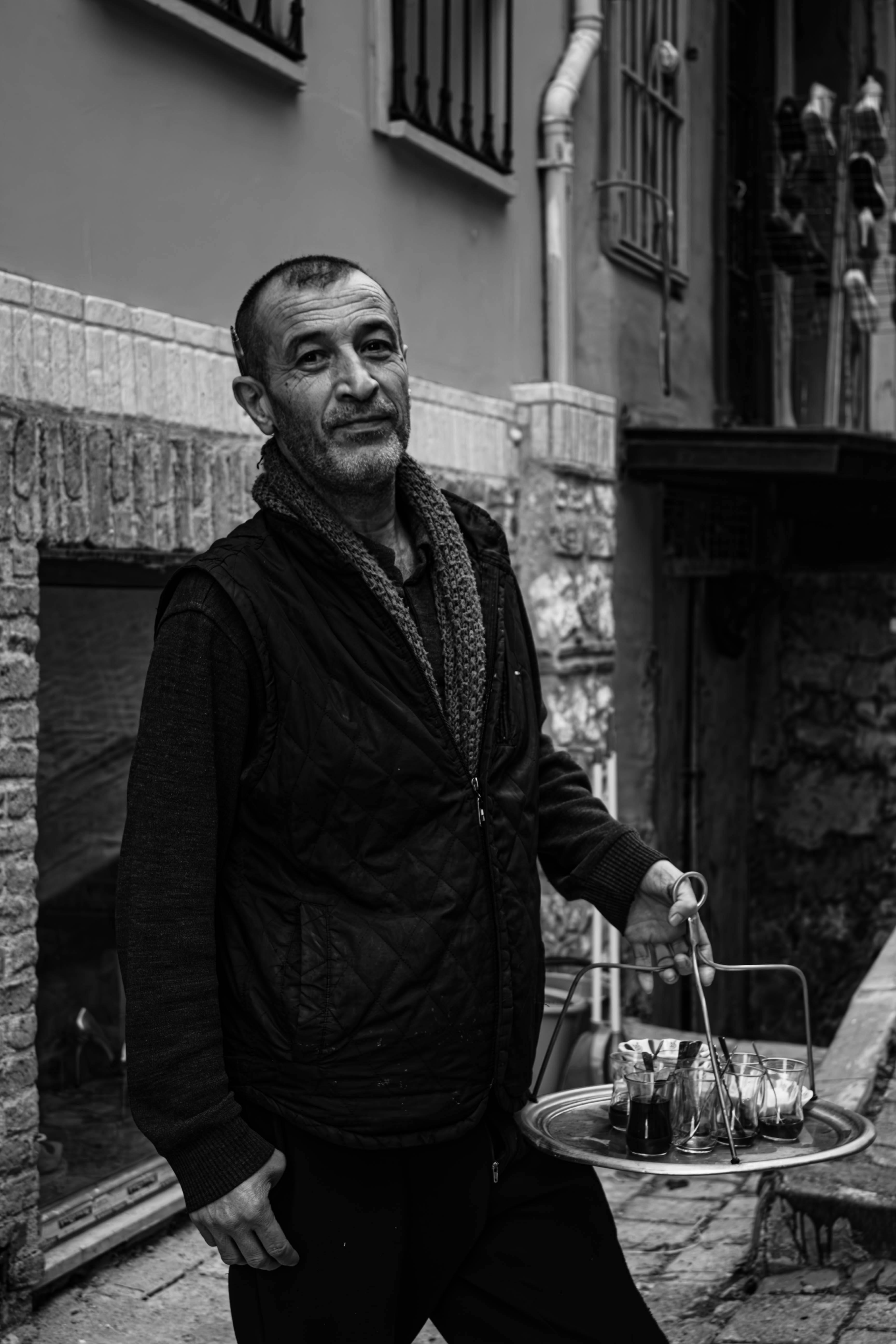 Black and White Photography of a Man Carrying Glass · Free Stock Photo