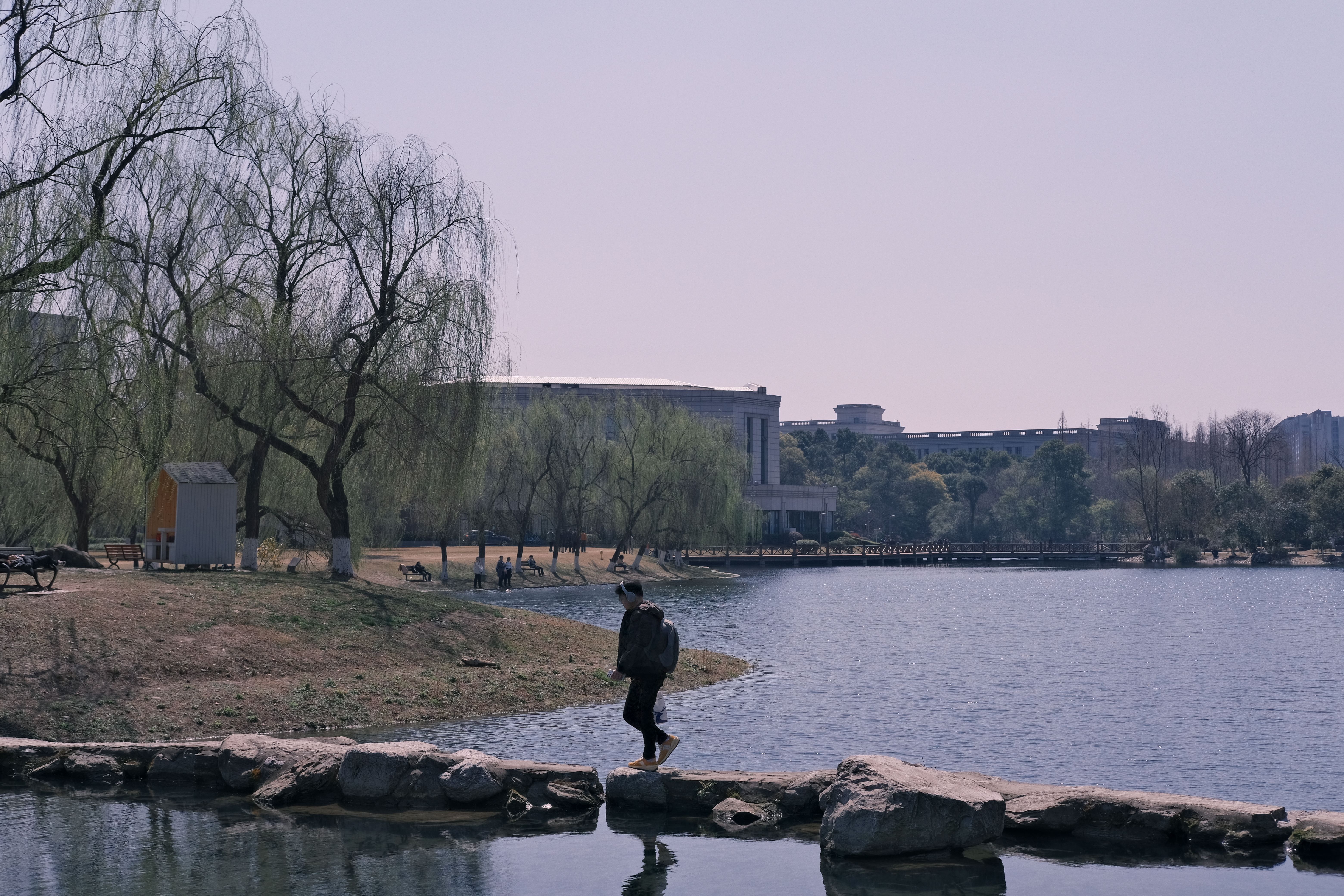 Man Walking on Rocks Boardwalk on Lake · Free Stock Photo