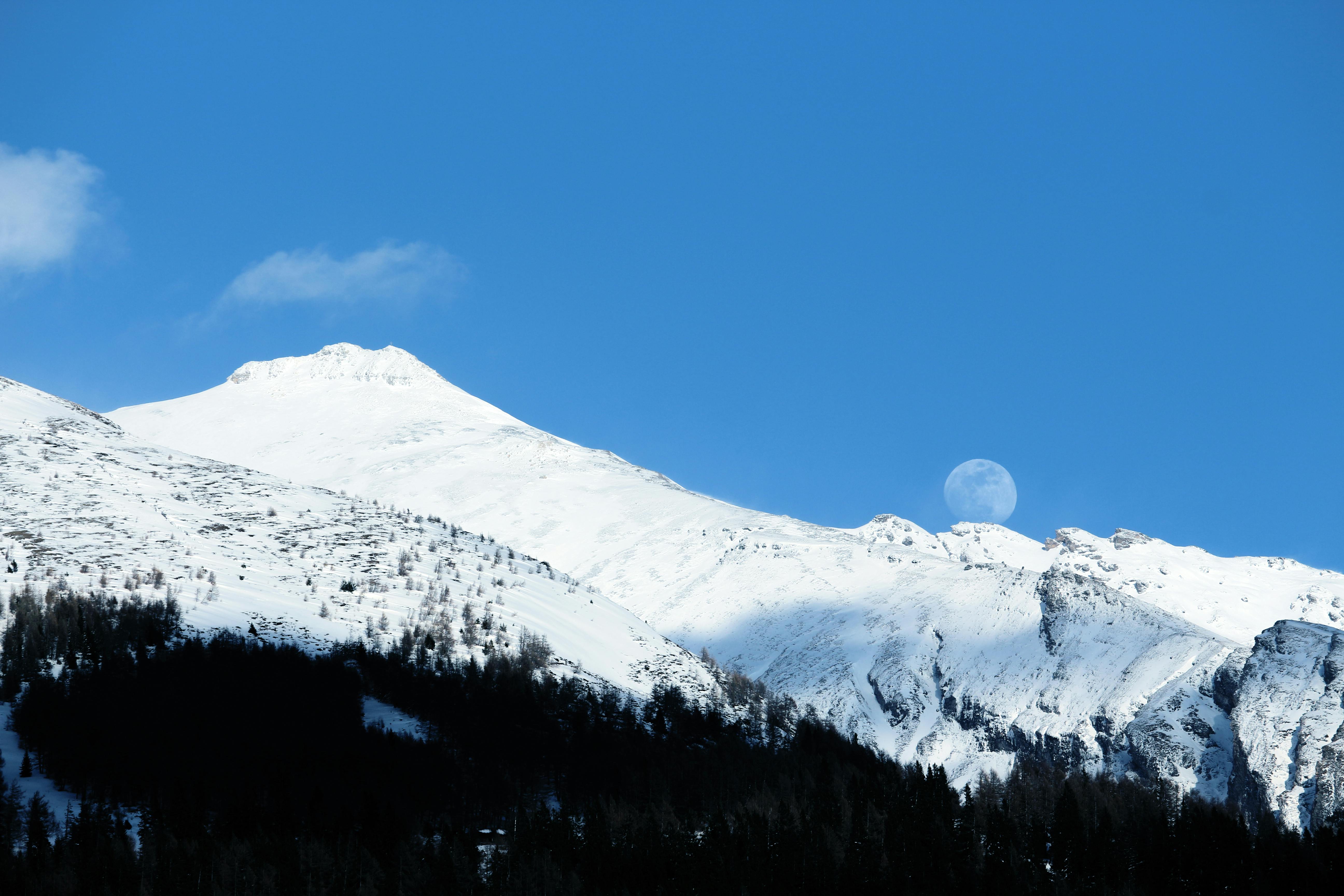 moon over snowy mountain · Free Stock Photo