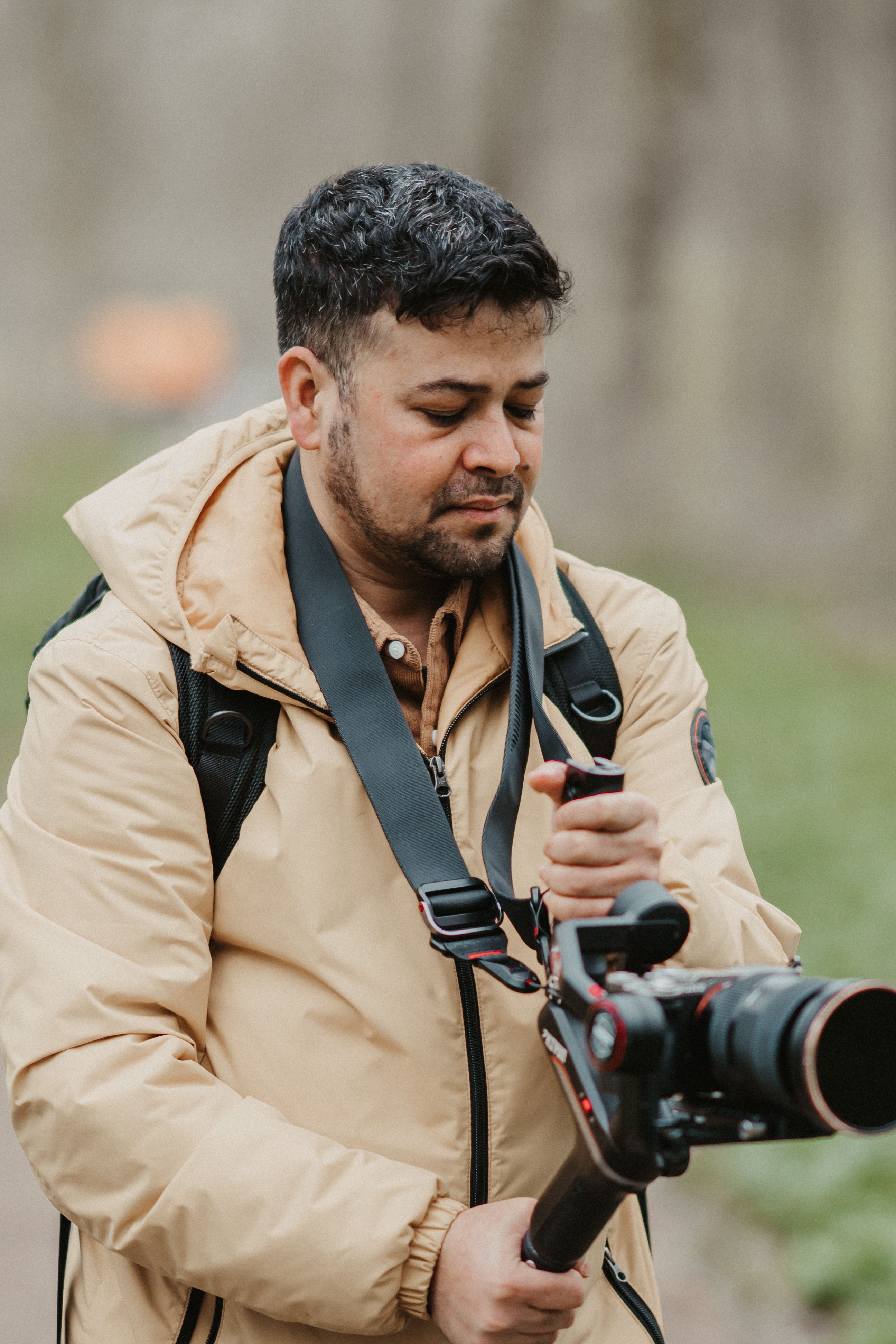 Man in Jacket Standing with Digital Camera · Free Stock Photo