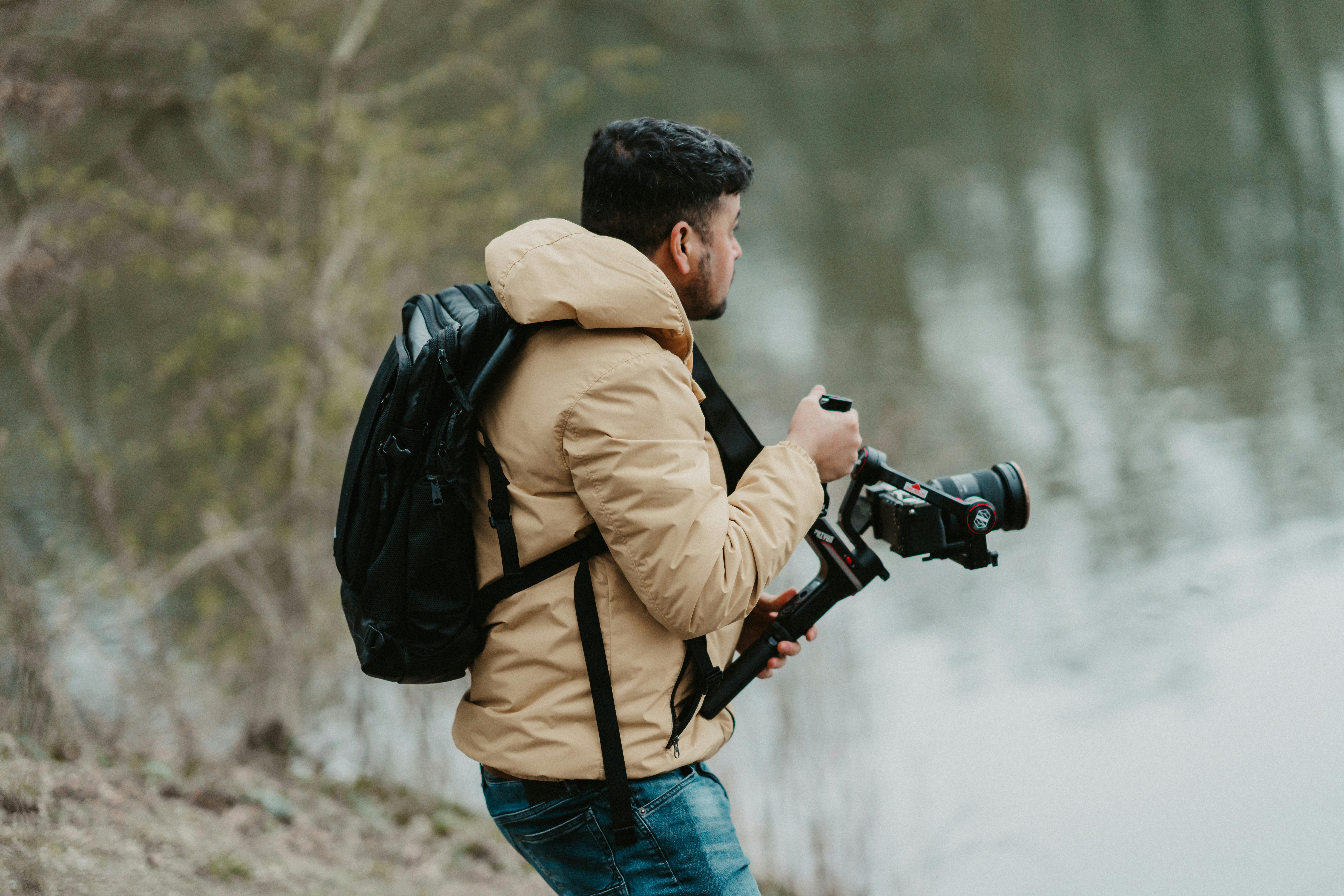 Side View of a Photographer Aiming His Camera · Free Stock Photo