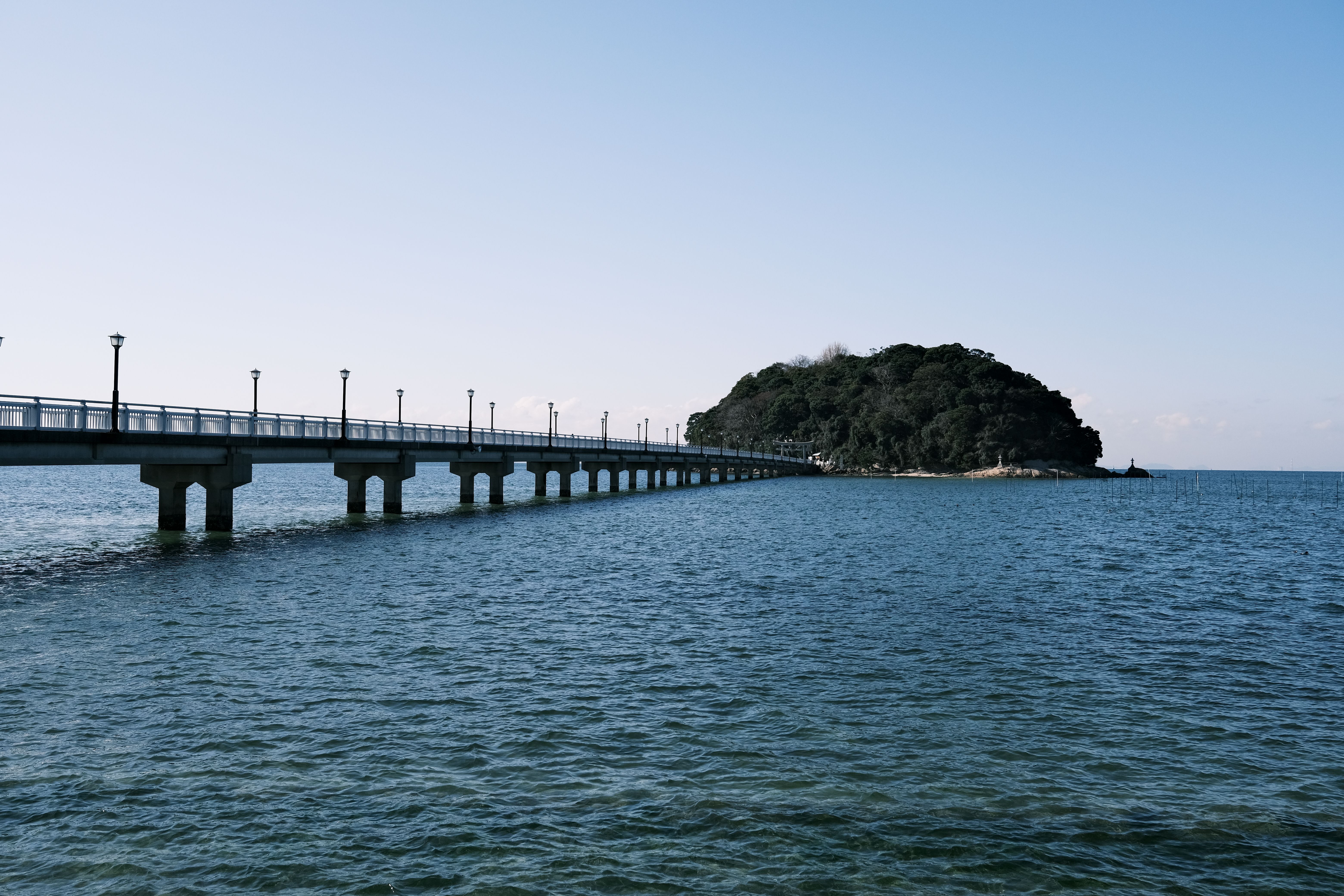 A long bridge over the water with a small island in the middle · Free ...