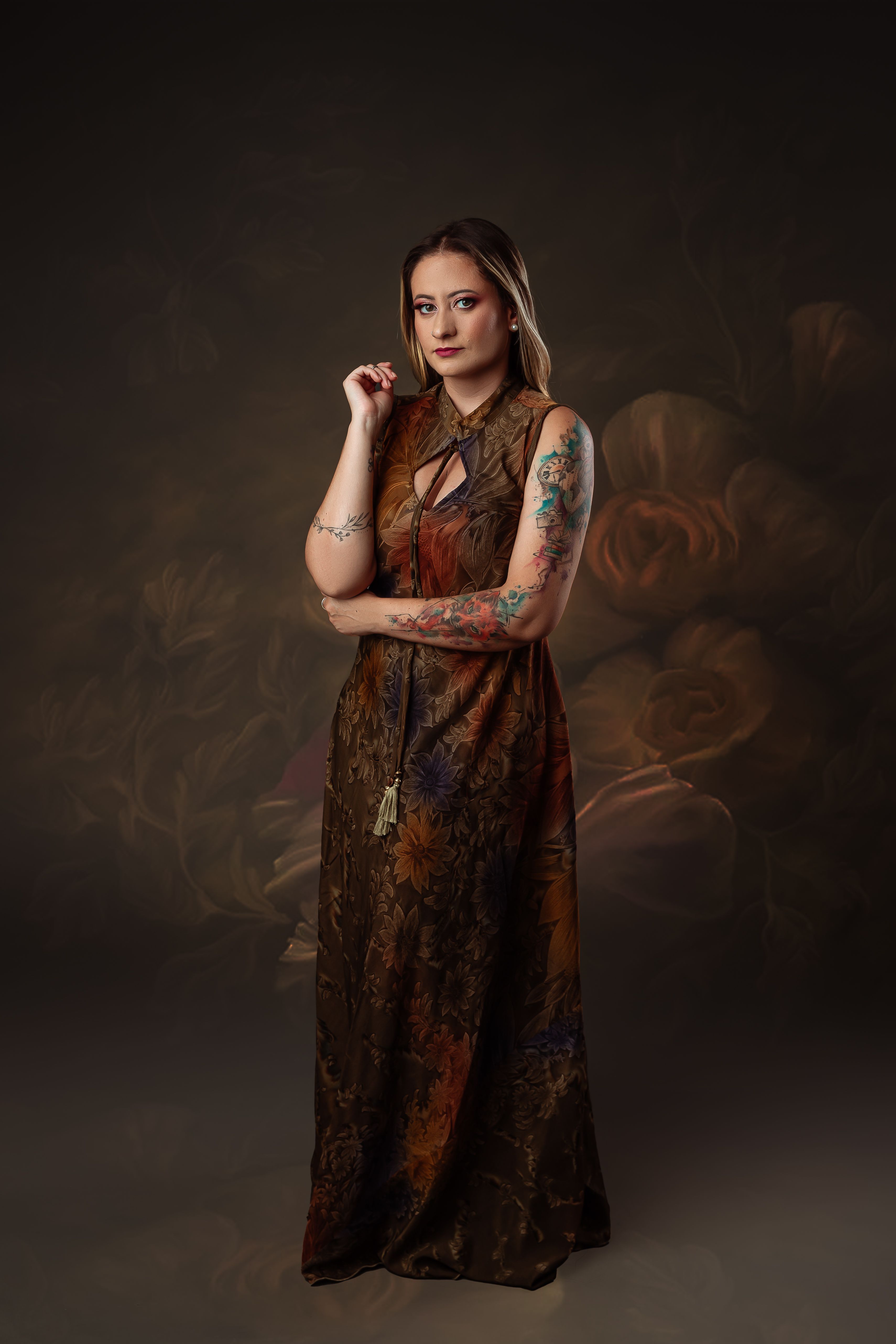 A woman with tattoos posing in a long dress · Free Stock Photo