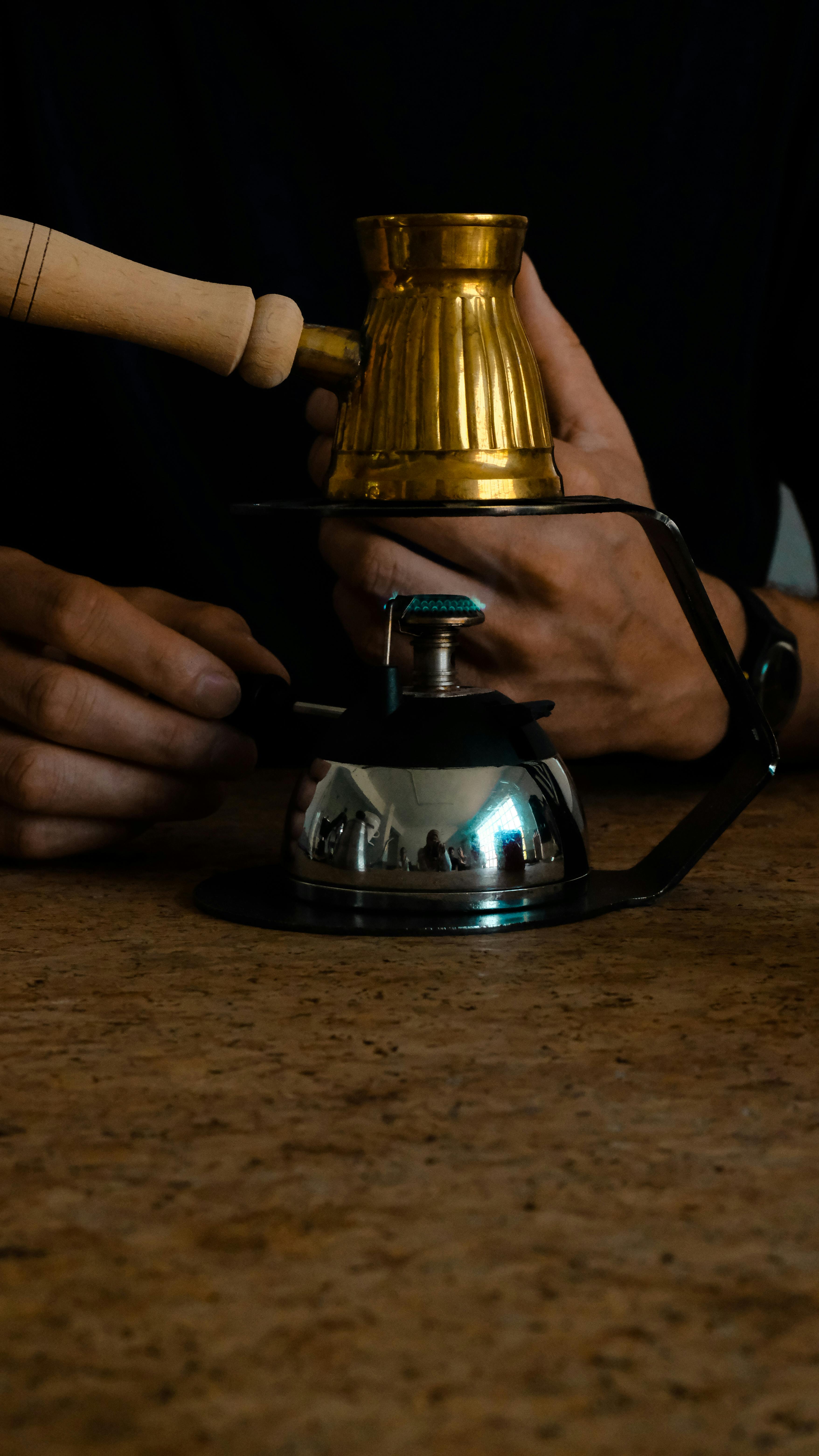 Man Hands Holding Burner and Pot · Free Stock Photo