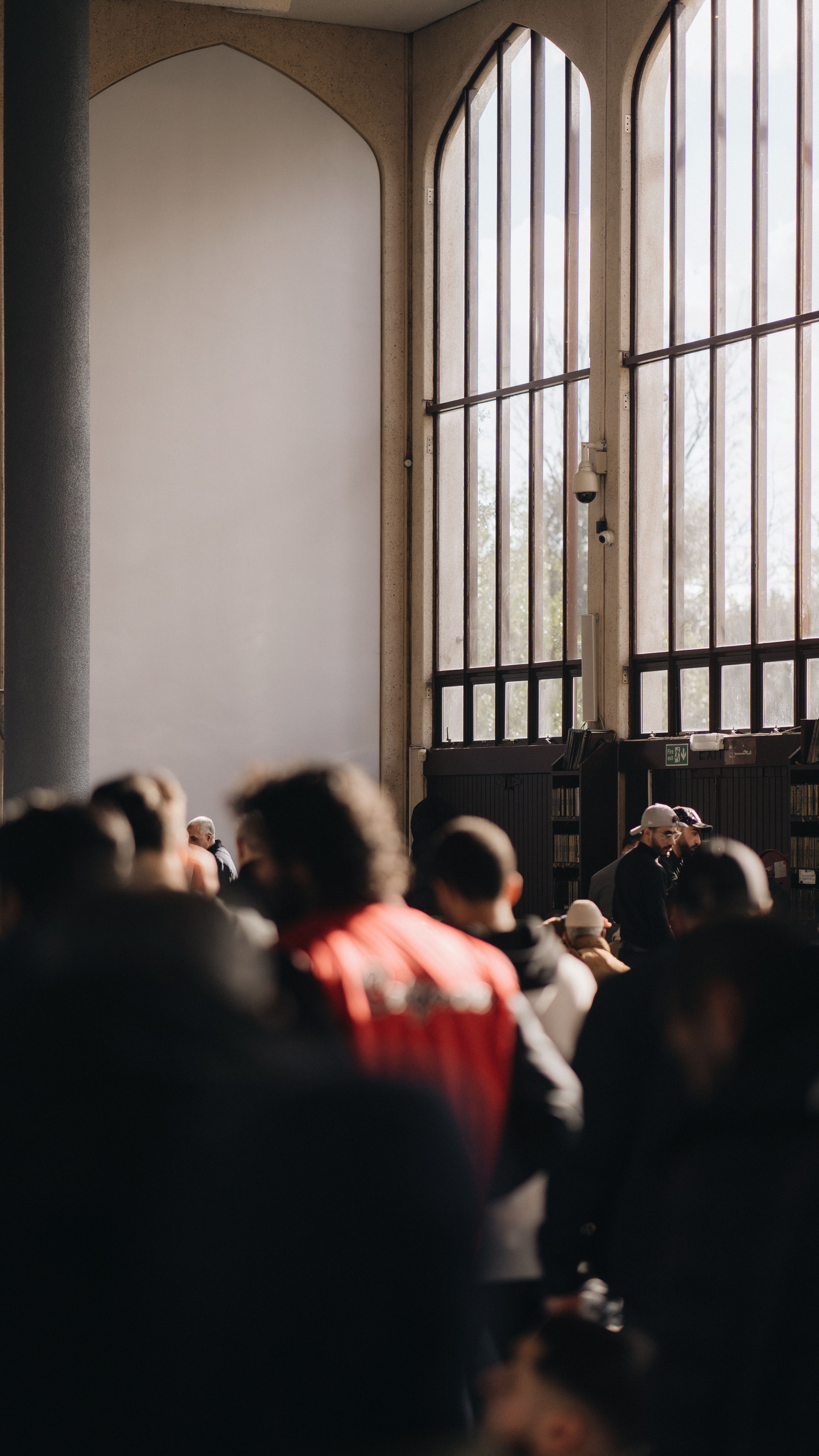 A crowd of people standing in front of a window · Free Stock Photo