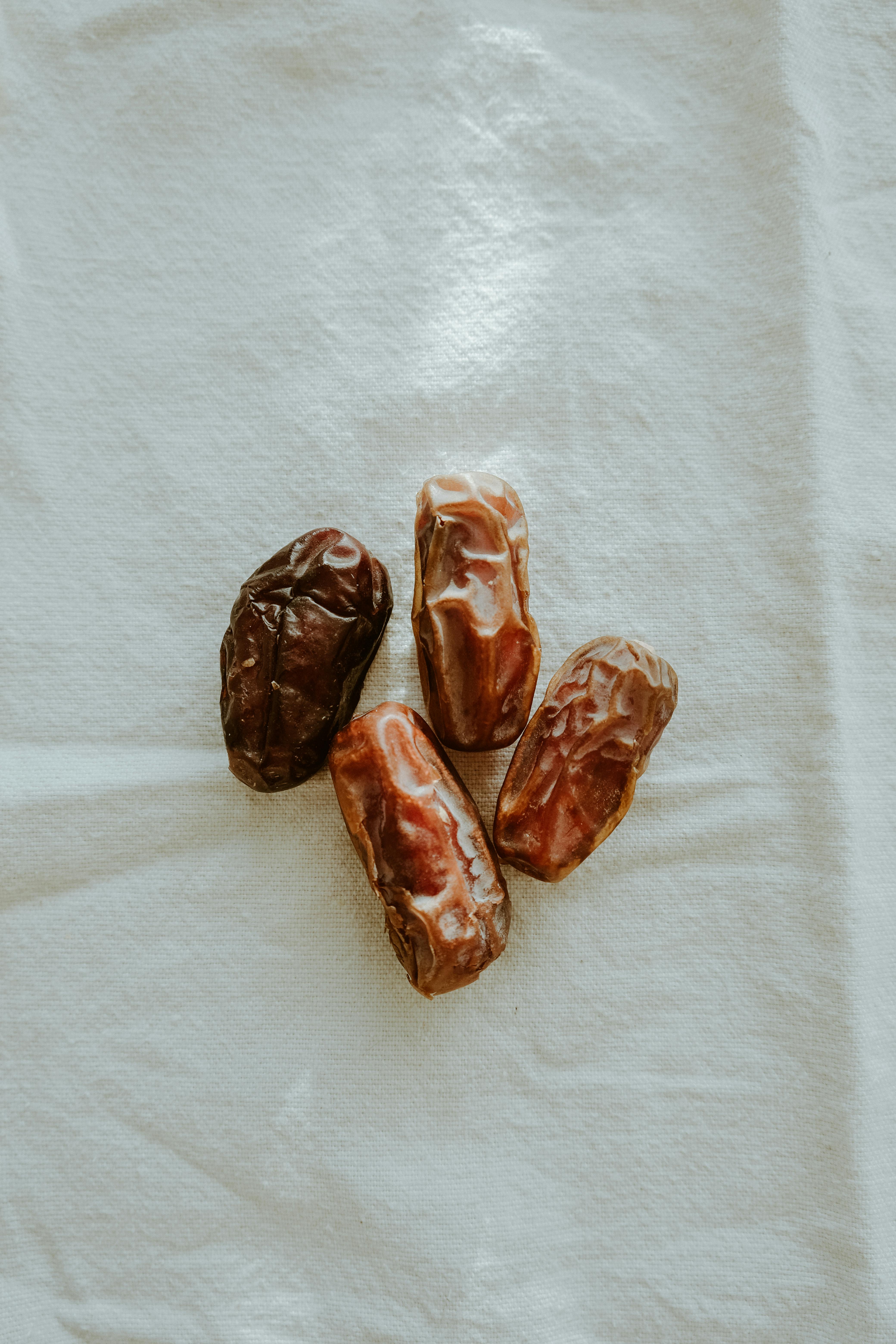 Four Dried Dates On the Tablecloth · Free Stock Photo