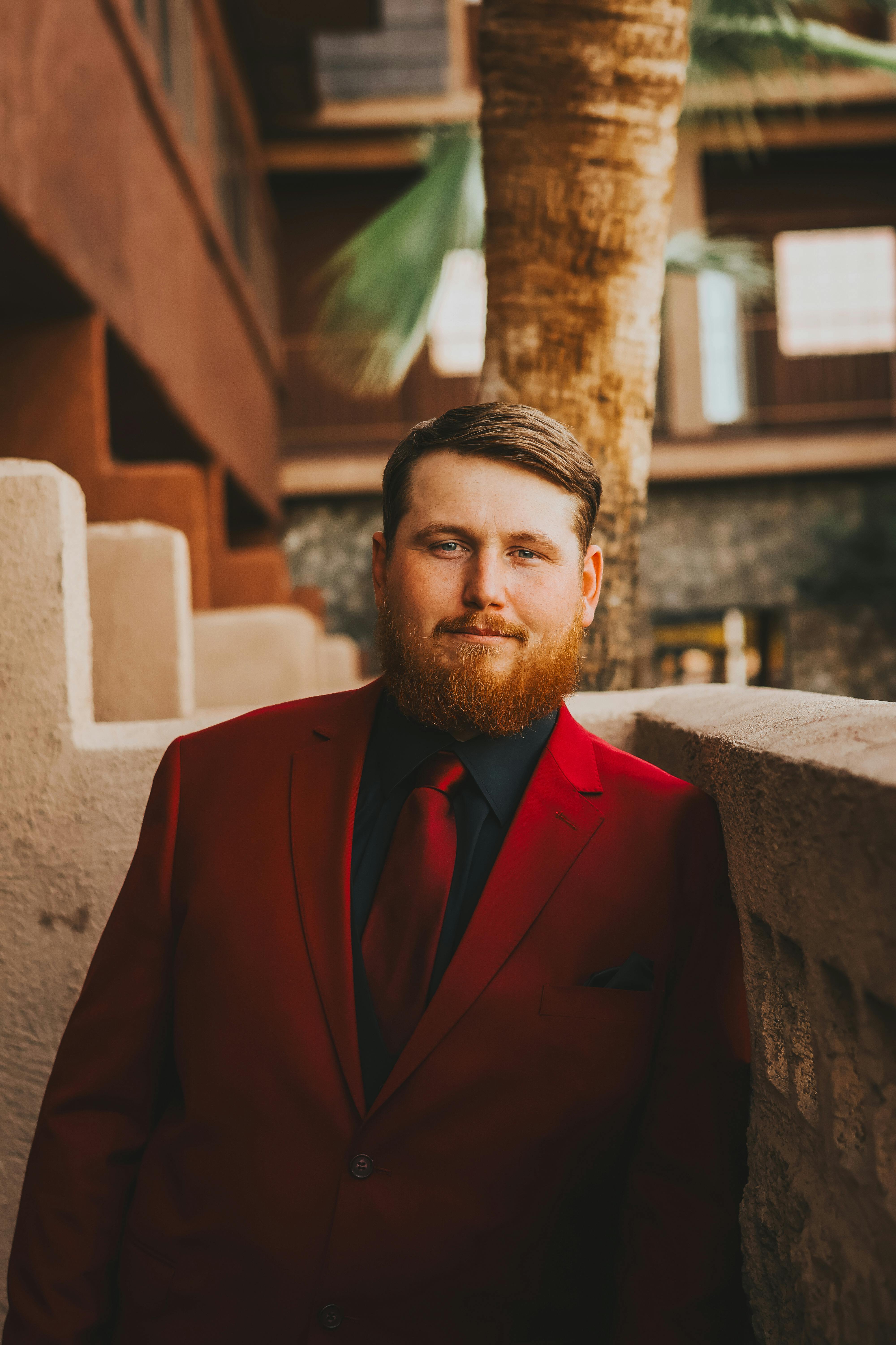 Portrait of Man Wearing Red Suit · Free Stock Photo