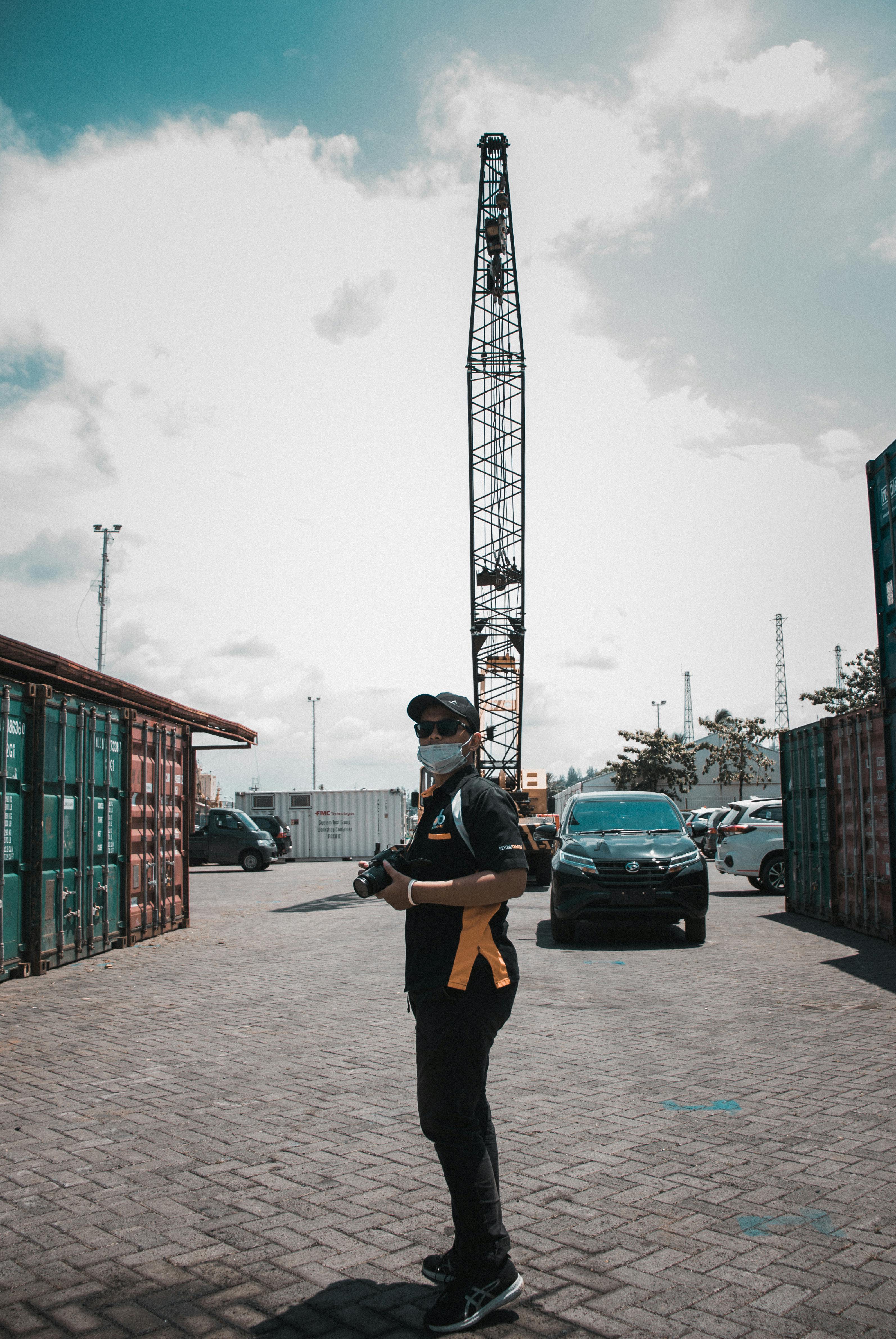 Man Standing Holding Camera · Free Stock Photo