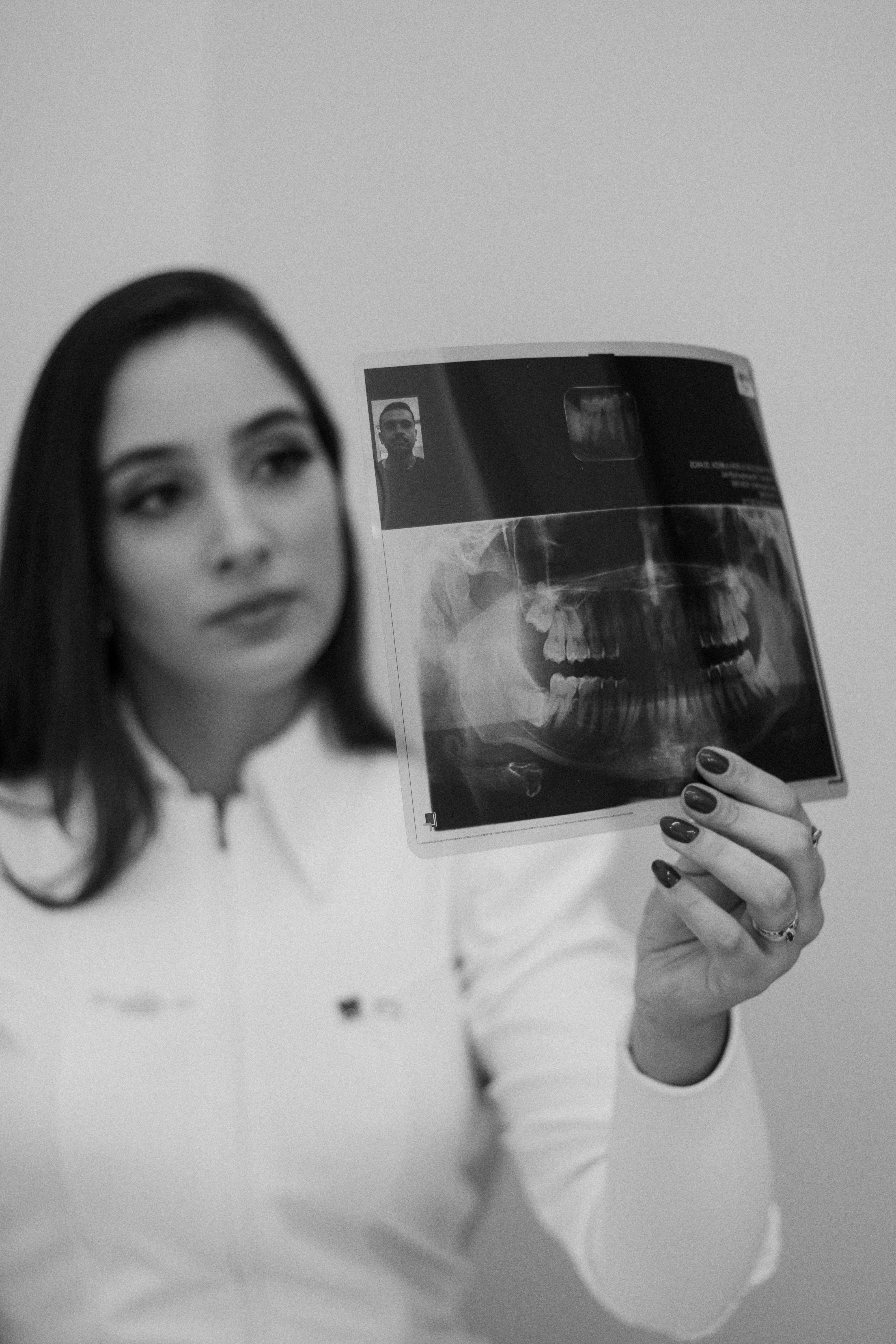 Dentist Standing and Holding RTG Picture · Free Stock Photo