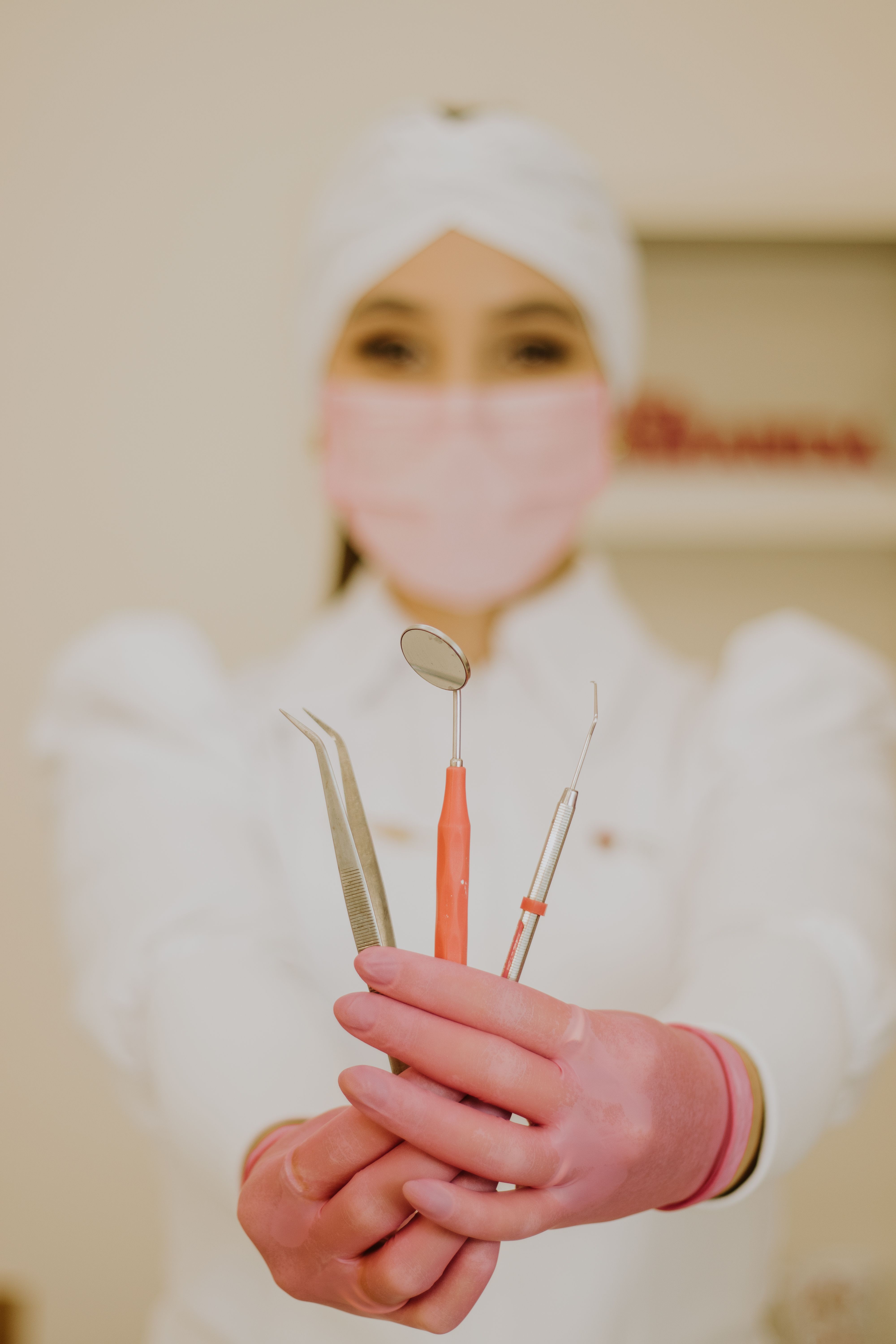 Dentist Holding Tools in Pink Gloves · Free Stock Photo