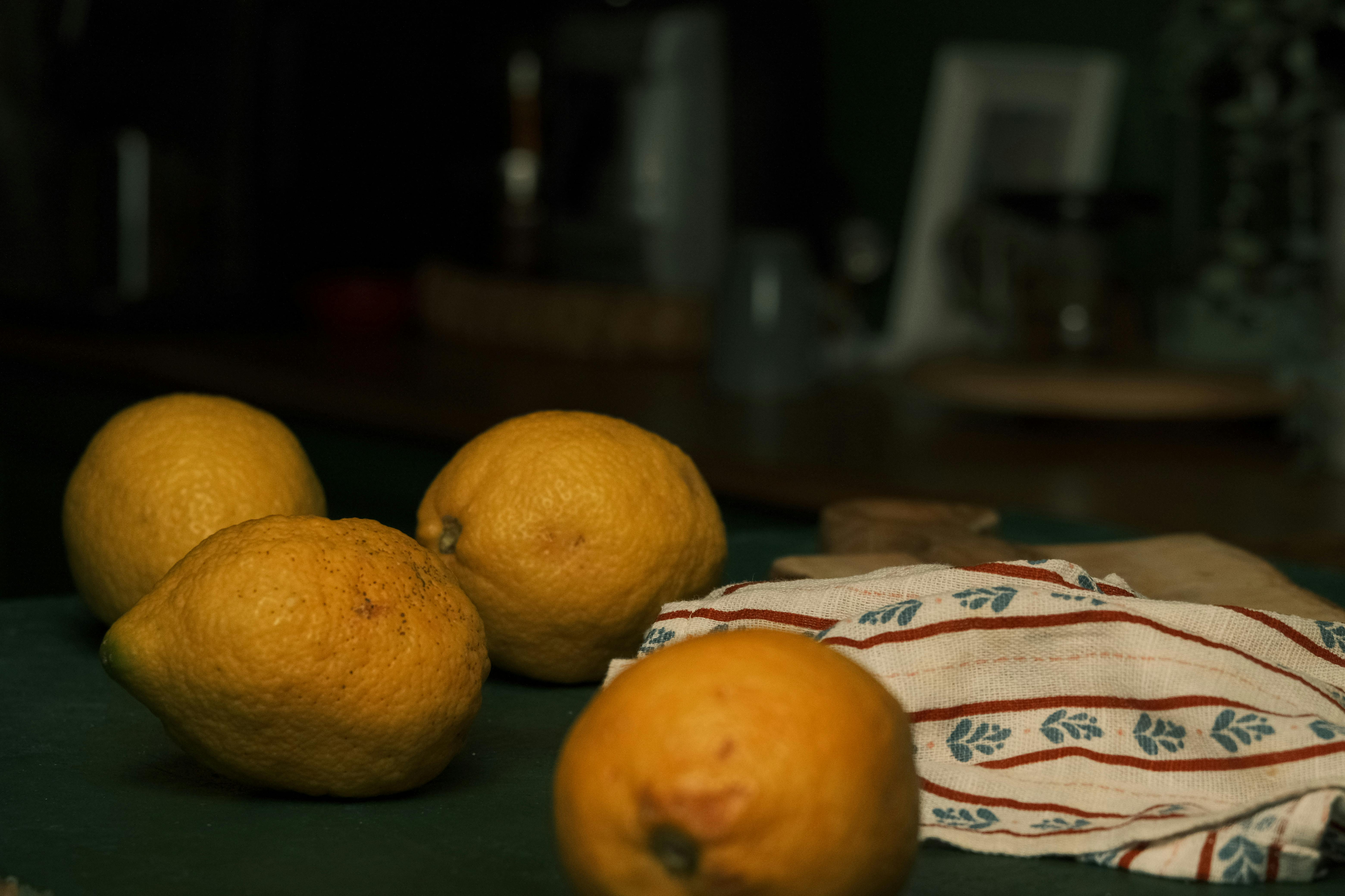 Lemons on a table with a cloth on top · Free Stock Photo