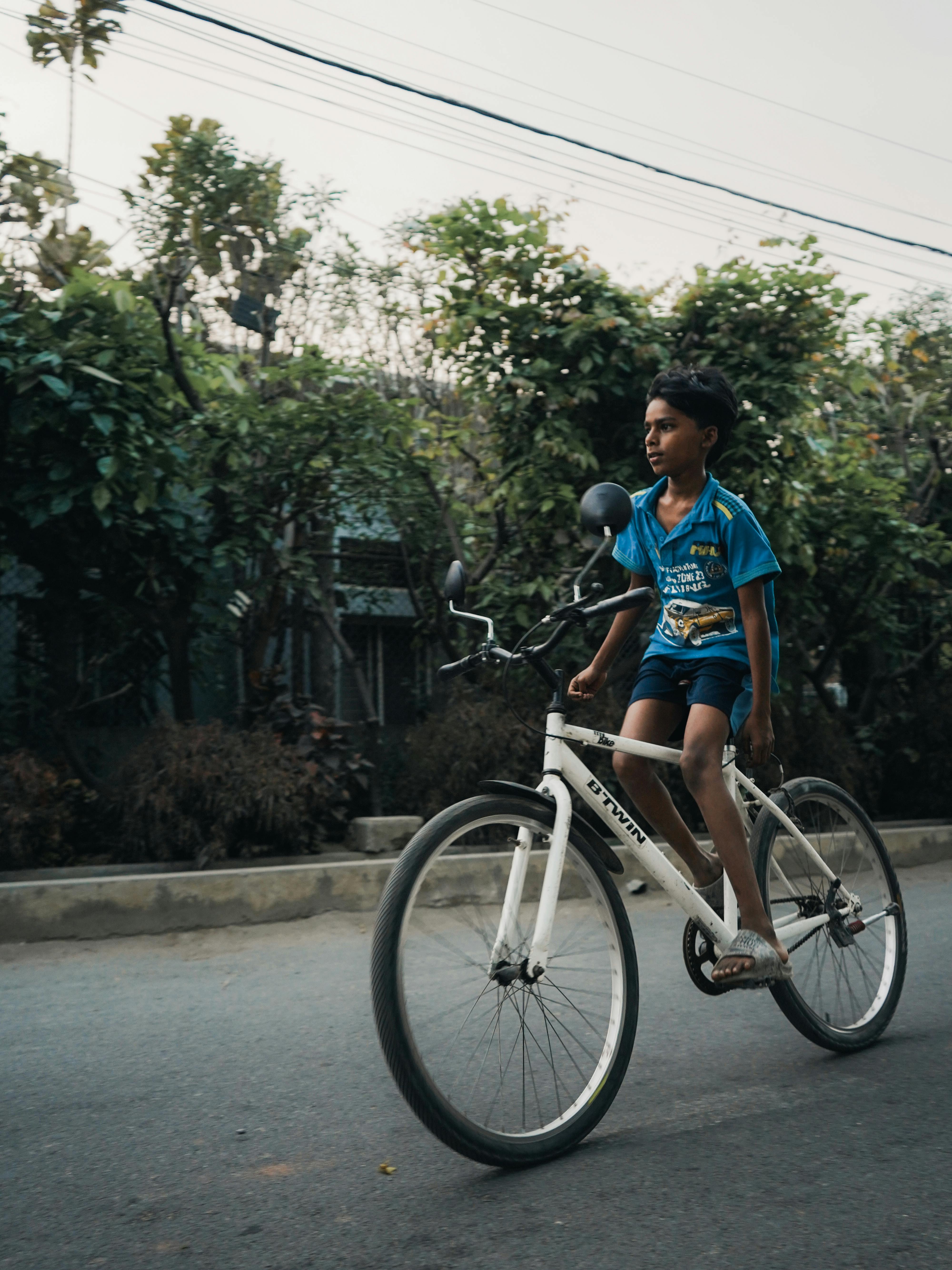 Boy Riding Bicycle on Street · Free Stock Photo