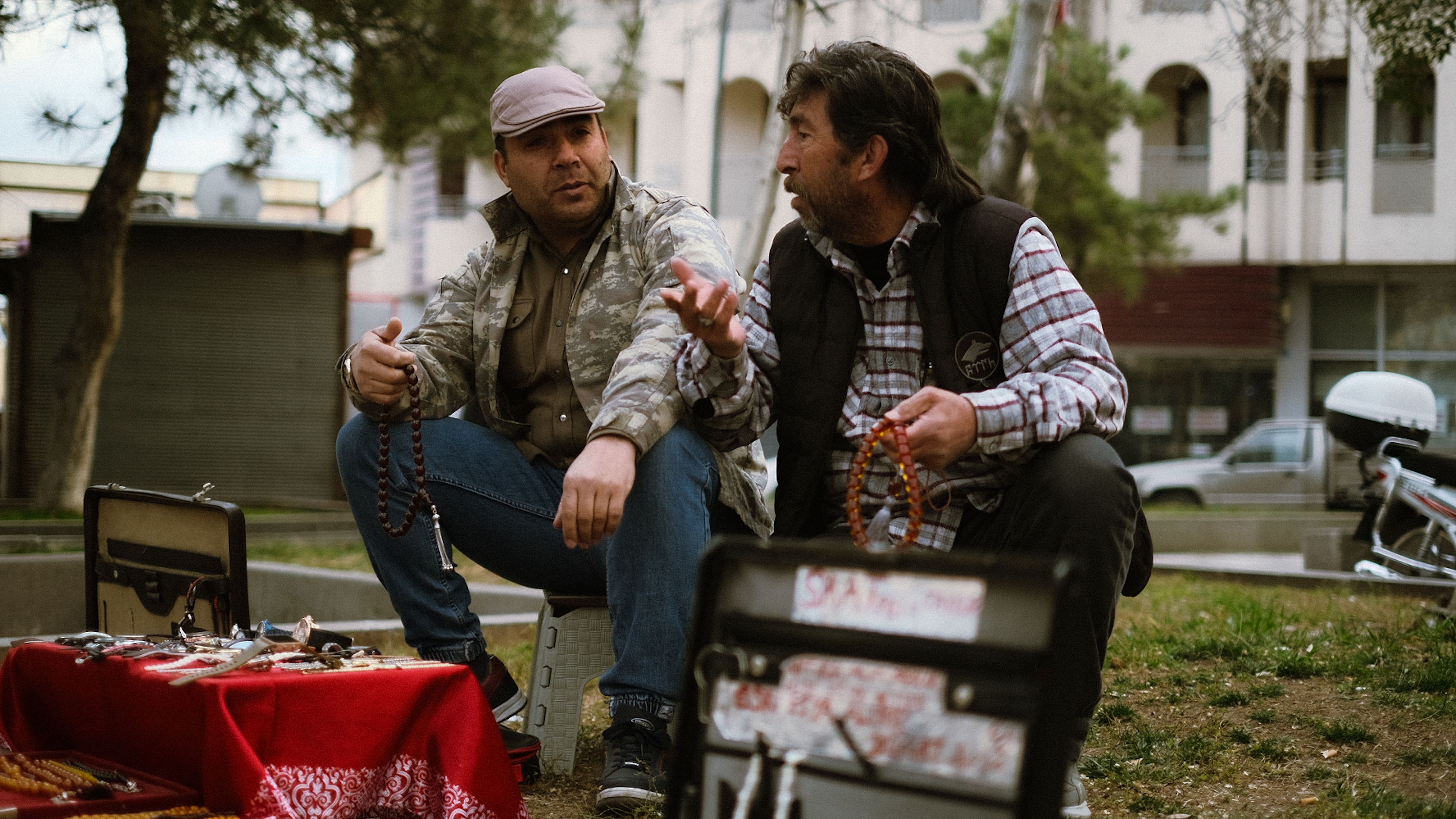 Two men sitting on a bench talking to each other · Free Stock Photo