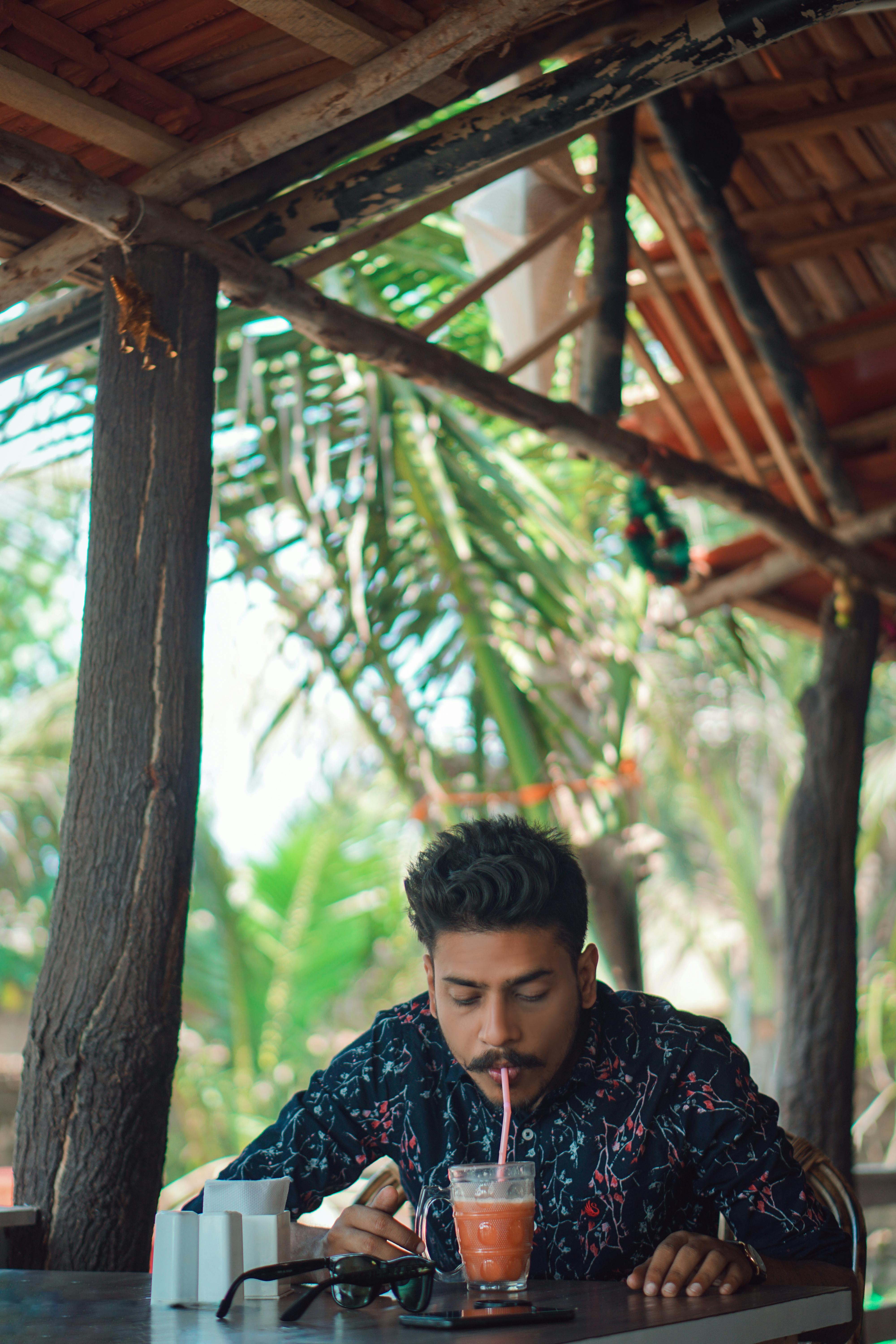 Man Sipping On Drink · Free Stock Photo