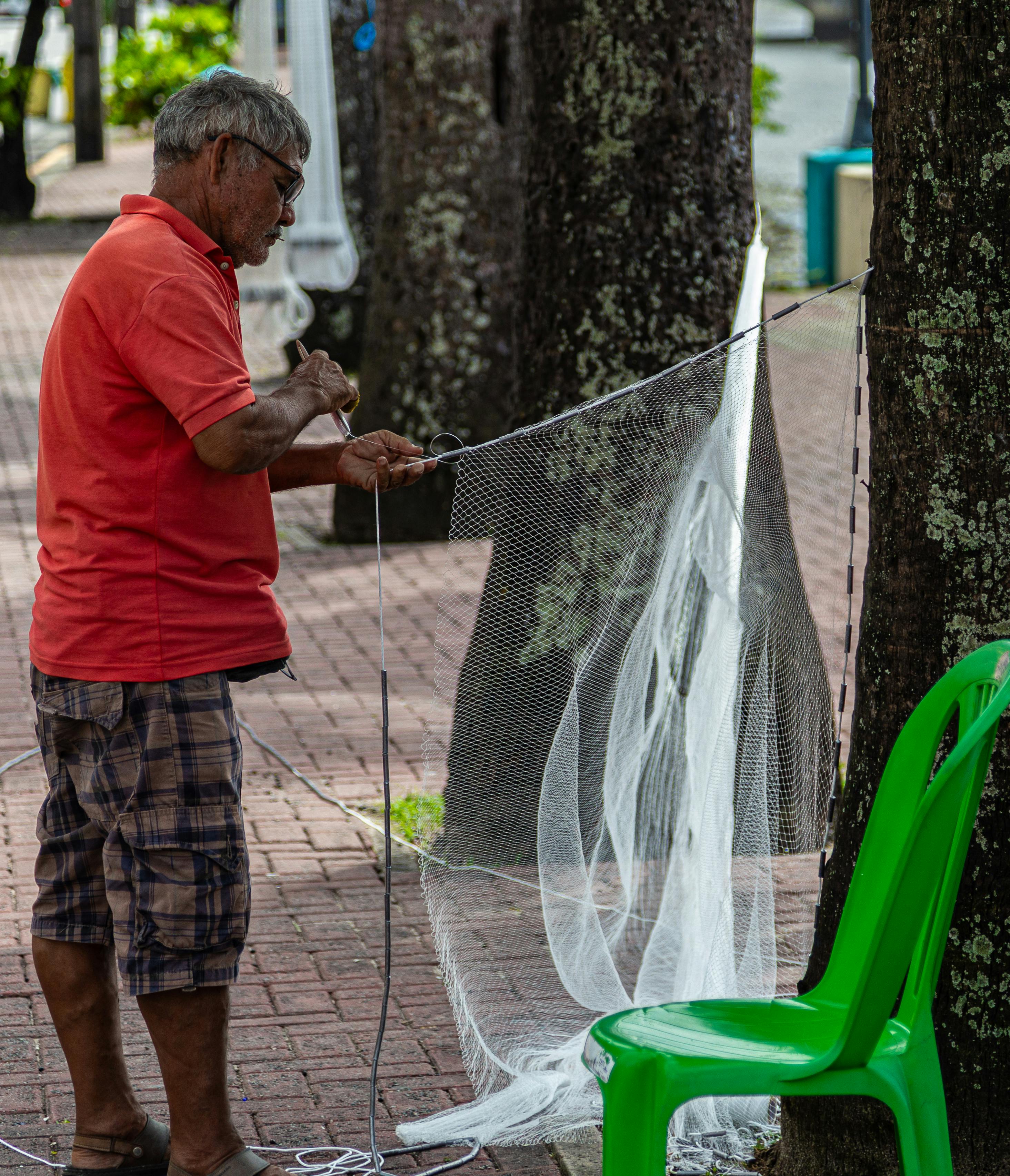 Elderly Fisherman Fixing Net · Free Stock Photo