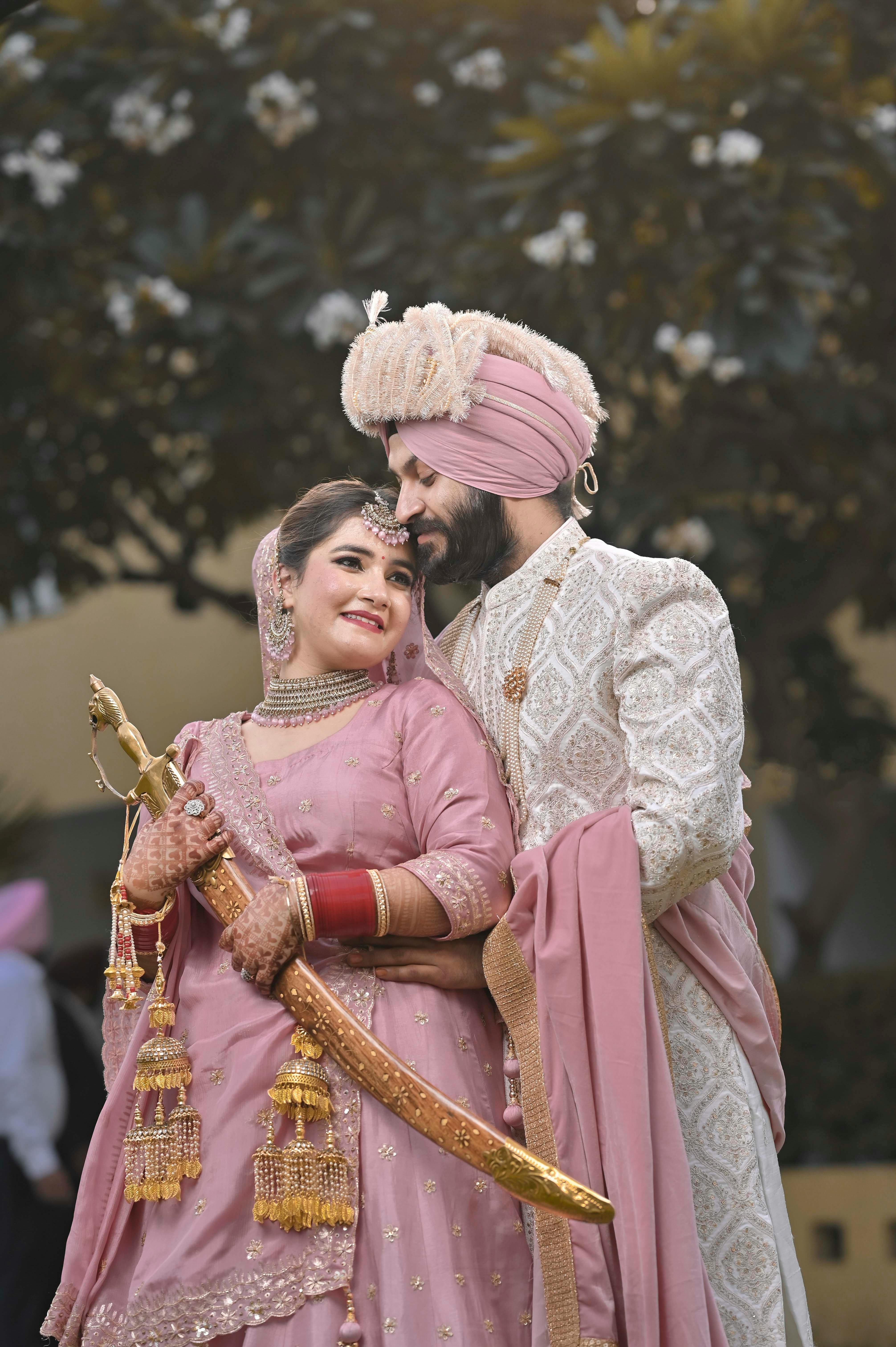 A couple in traditional attire pose for a photo · Free Stock Photo