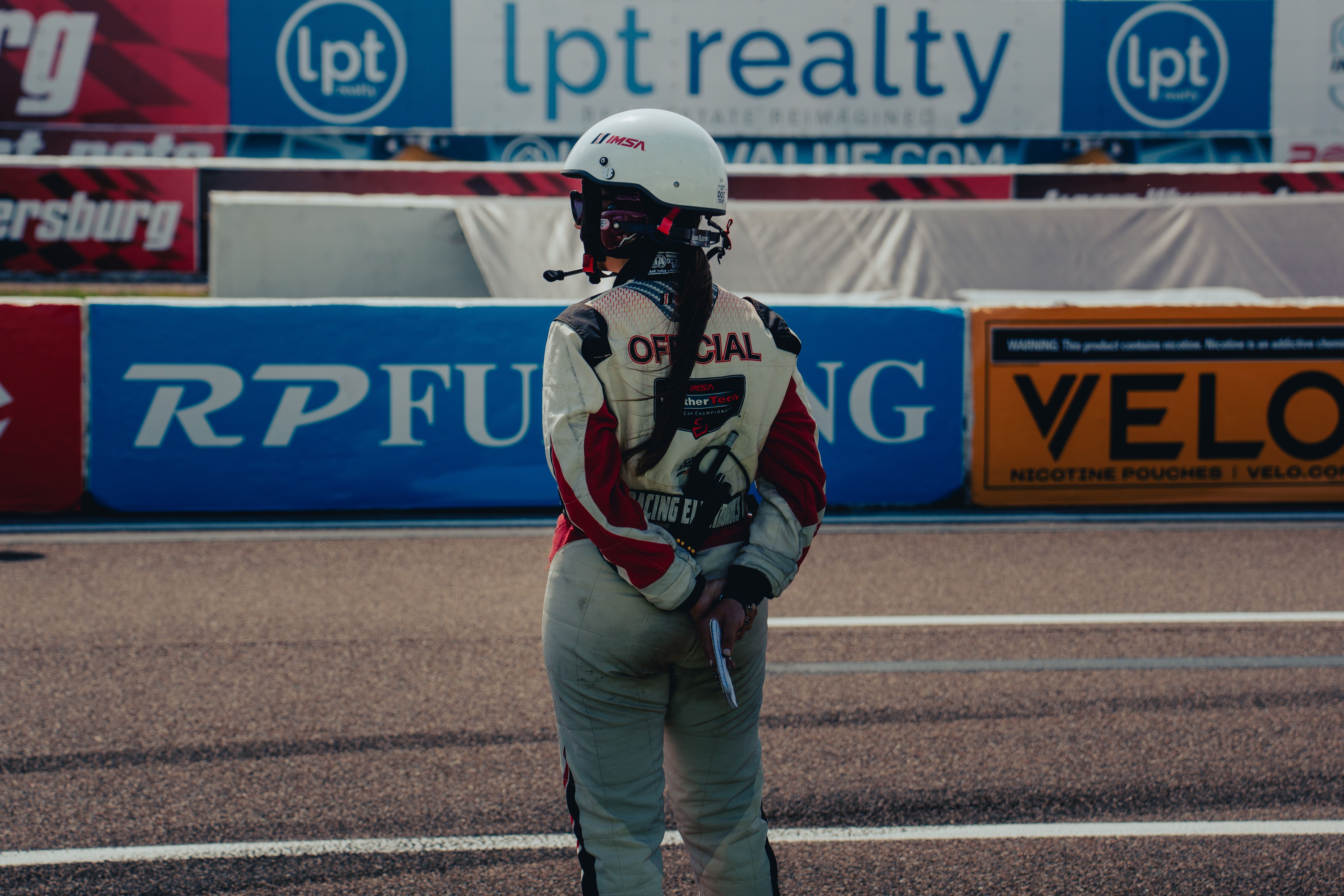 Racer in Helmet Standing by Track · Free Stock Photo