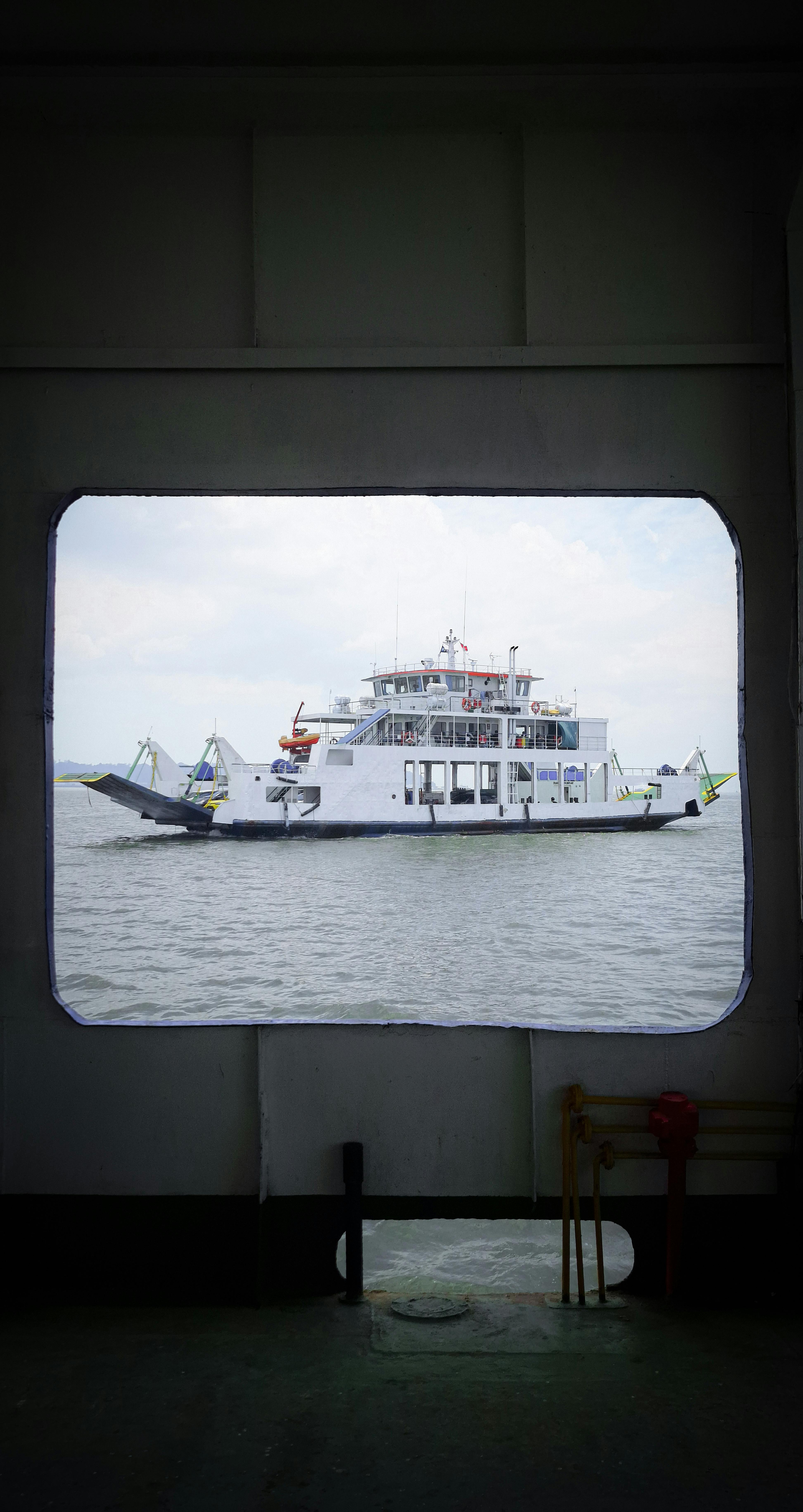 Window View of Small Car Ferry on Water · Free Stock Photo