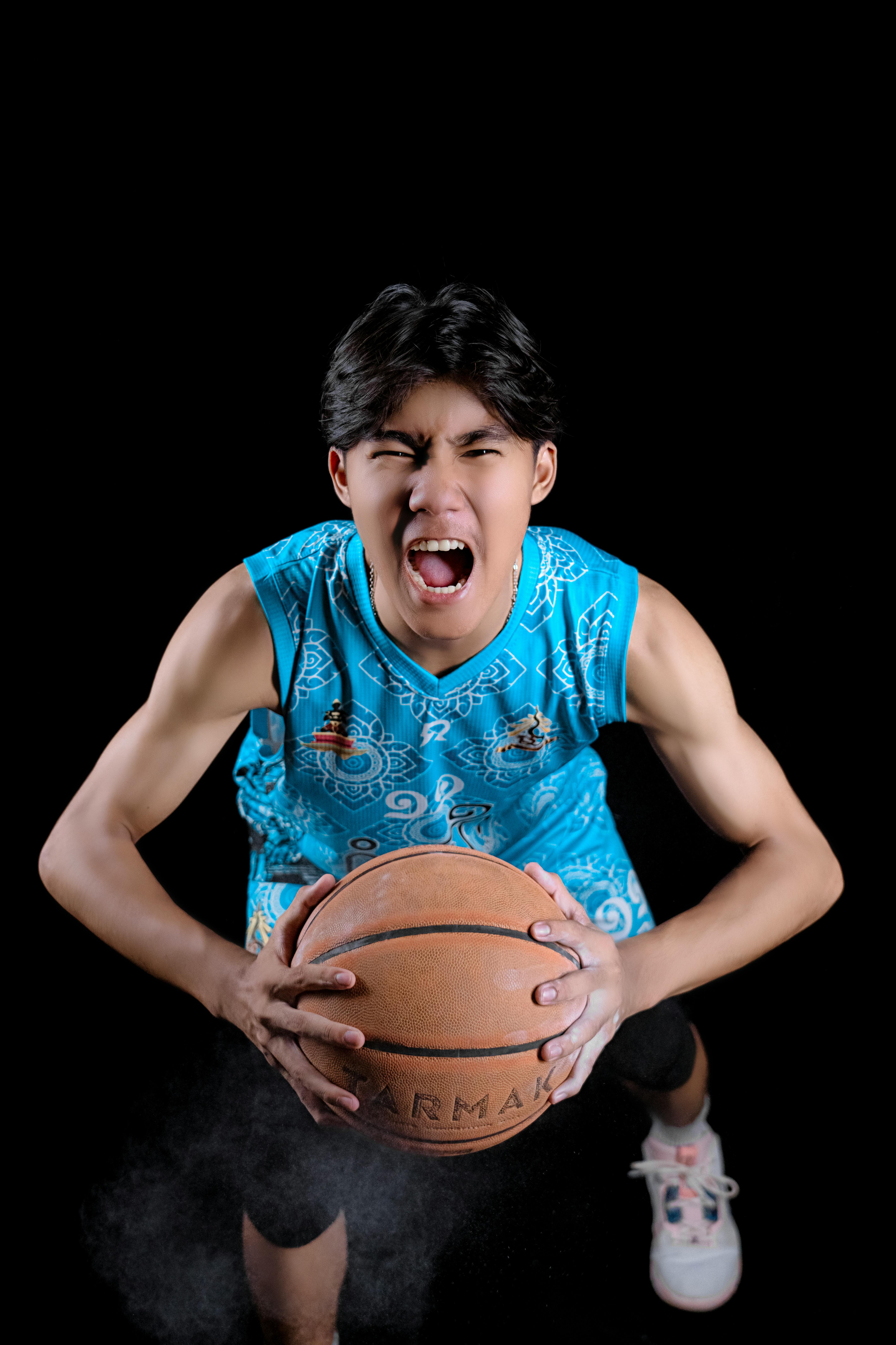 Basketball Player Screaming and Holding Ball with Both Hands · Free ...