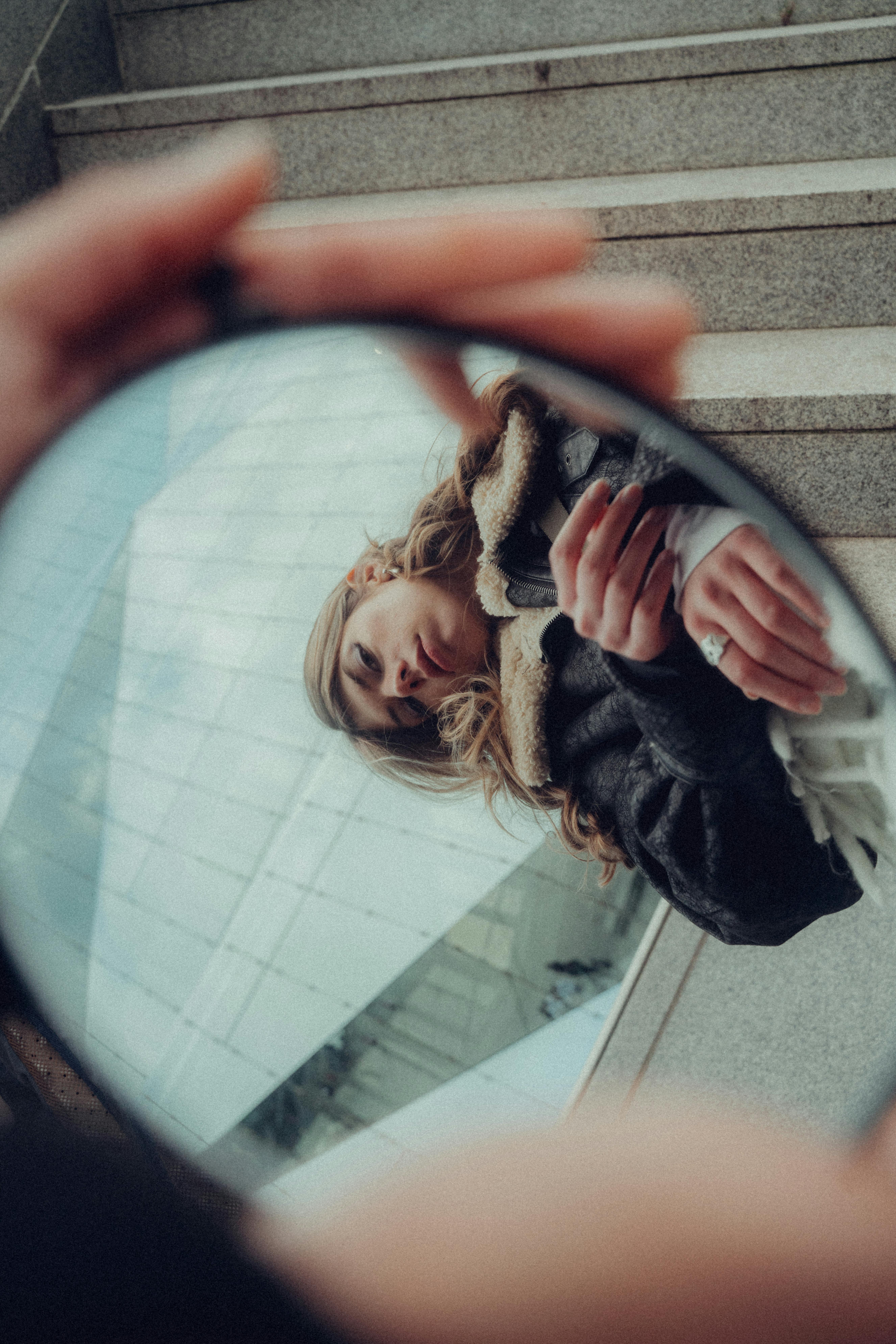 Woman Hand Holding Mirror with Face Reflection · Free Stock Photo