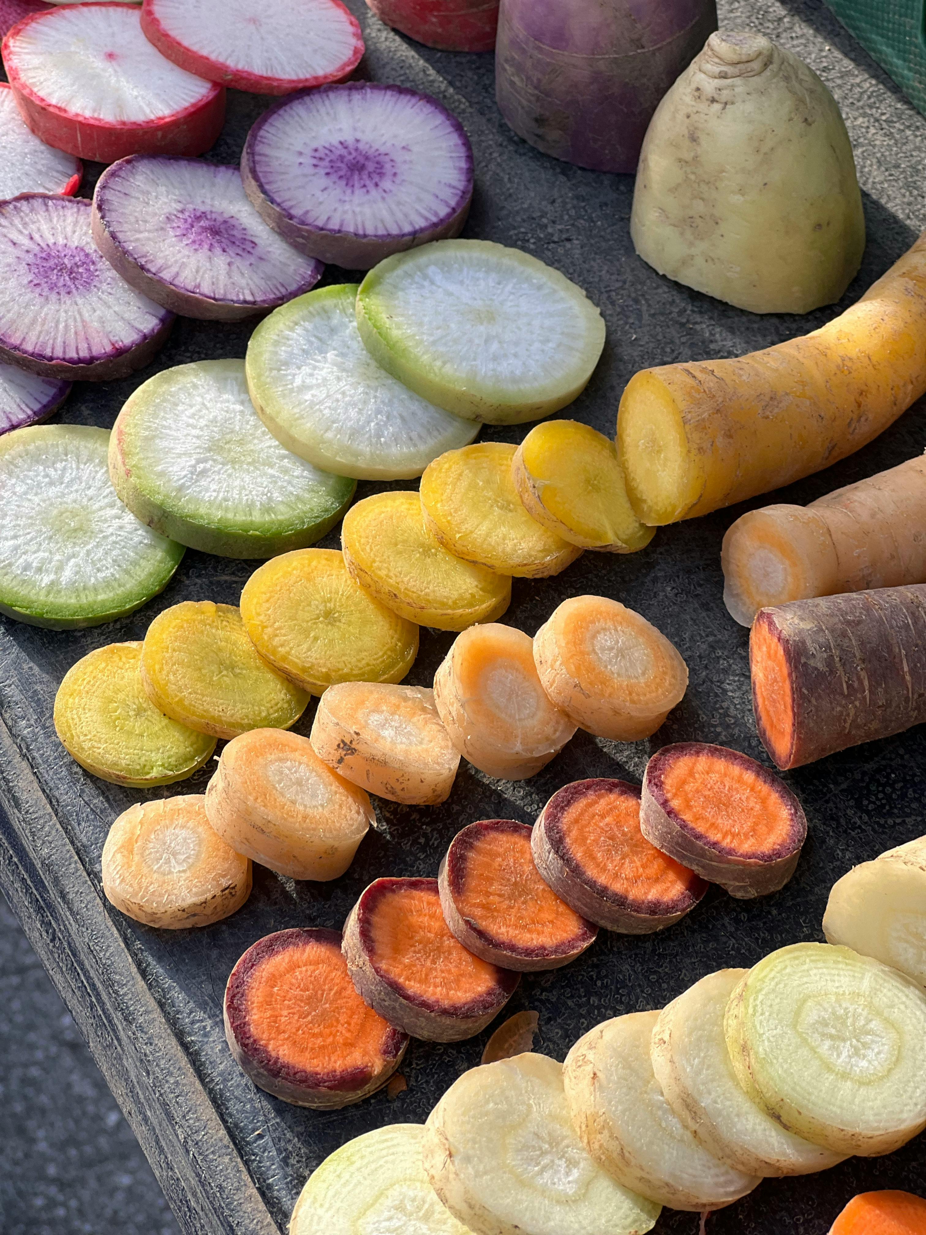 A display of different colored carrots and other vegetables · Free ...