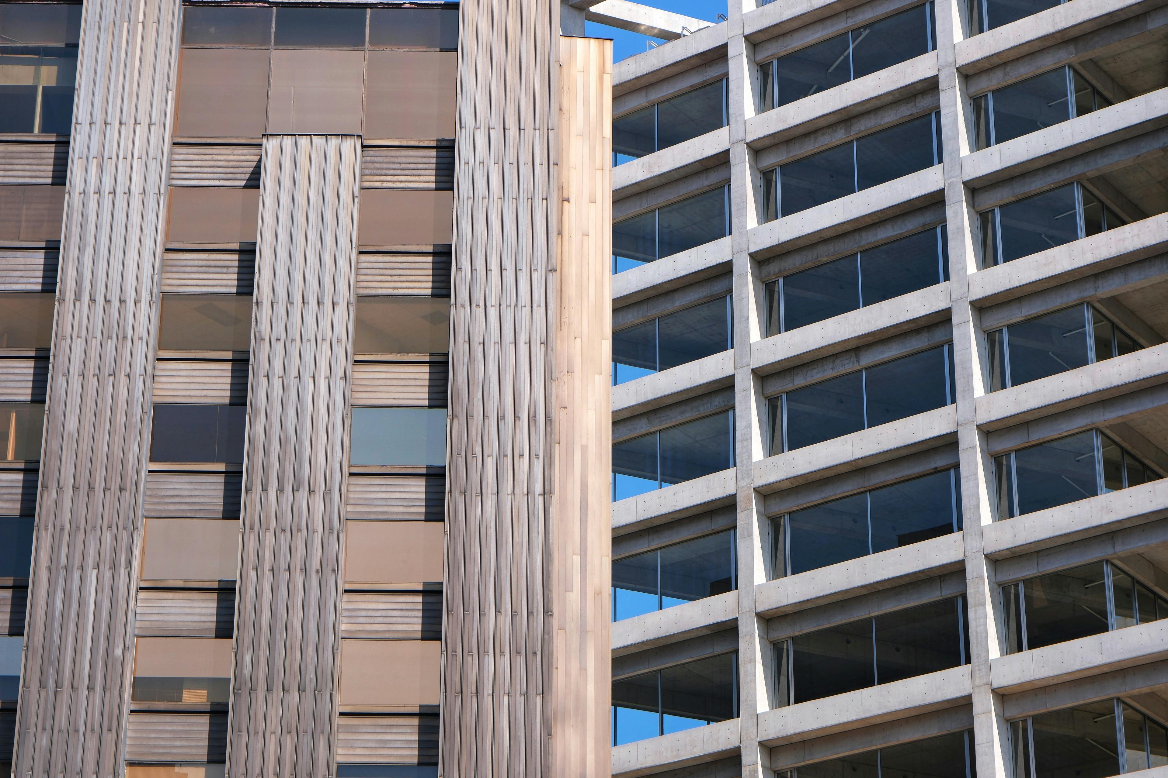 Concrete Skyscraper Under Construction Next to an Office Building ...
