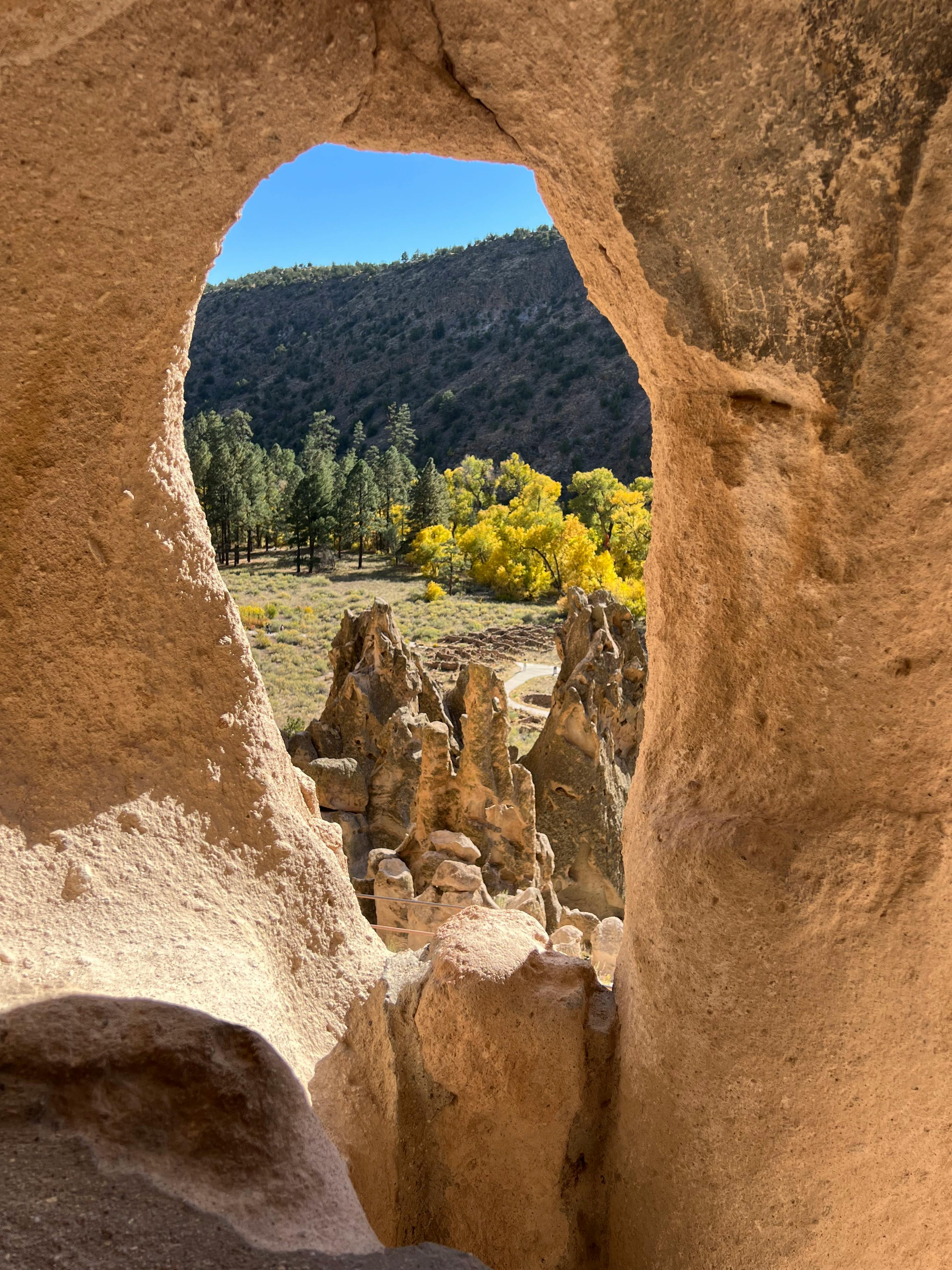 Trees and Rock Formations behind Gap in Rocks · Free Stock Photo