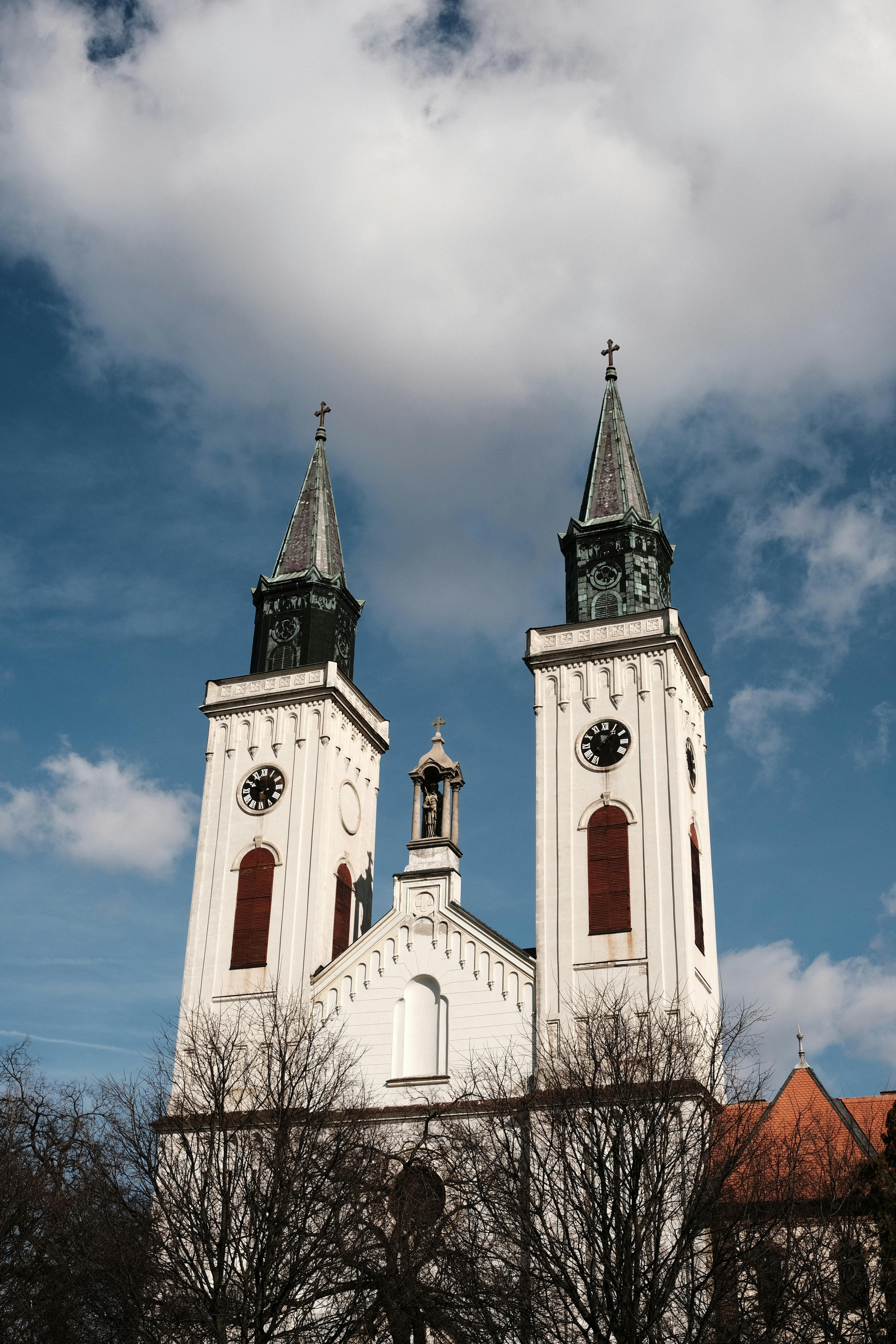 A church with two towers and a clock on the side · Free Stock Photo