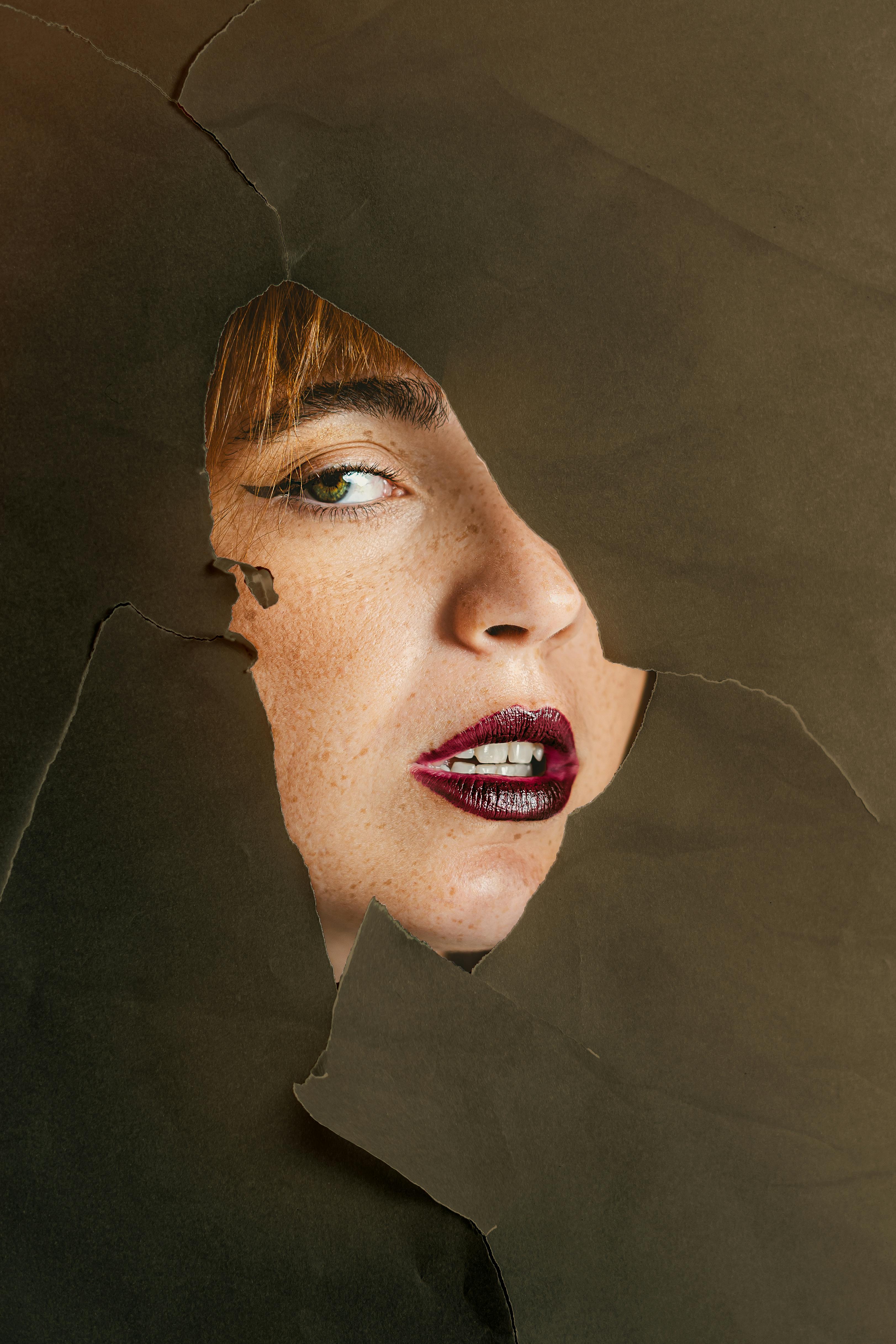 A woman with her face covered in a hole · Free Stock Photo