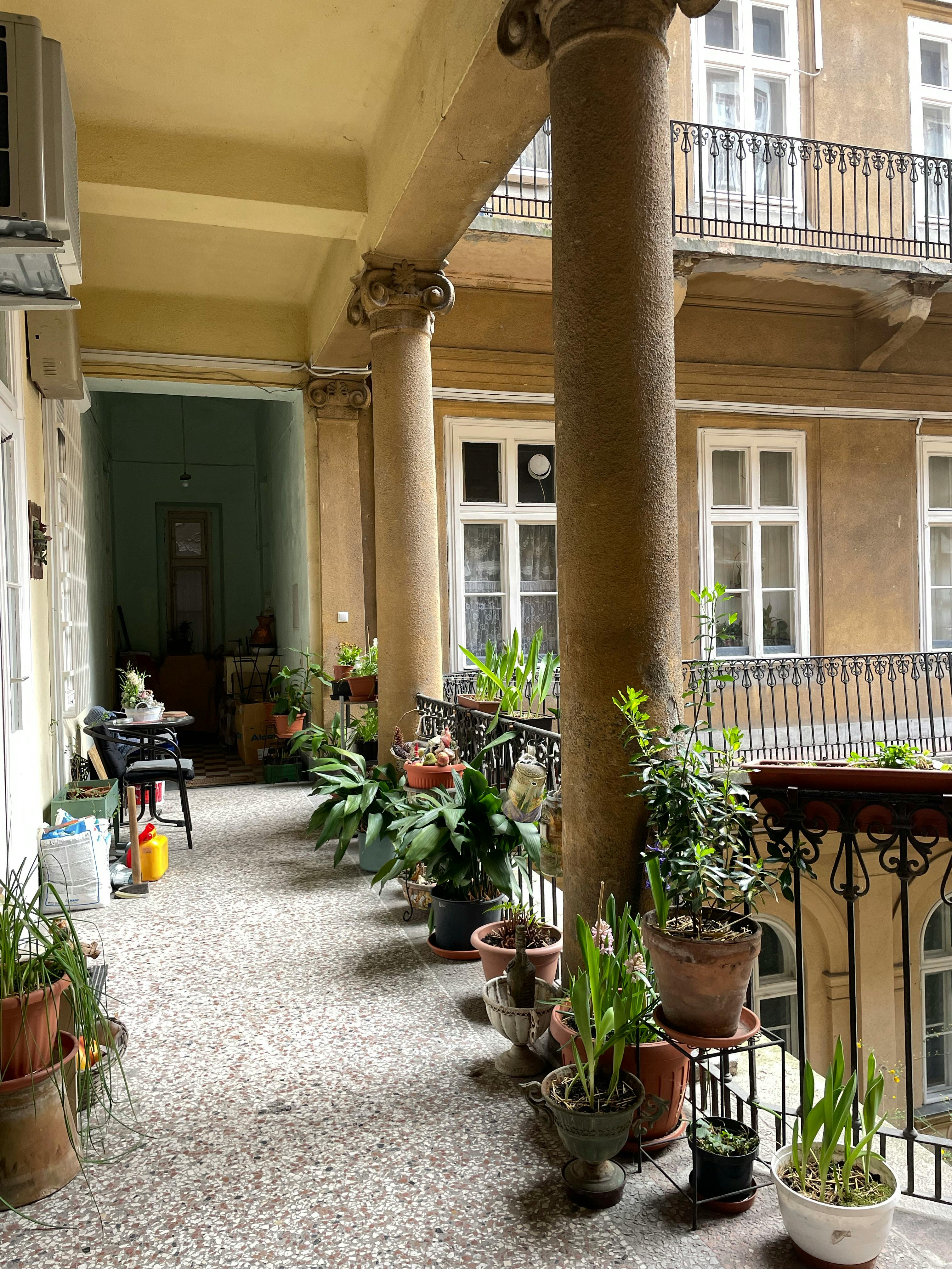 A balcony with potted plants and a table · Free Stock Photo