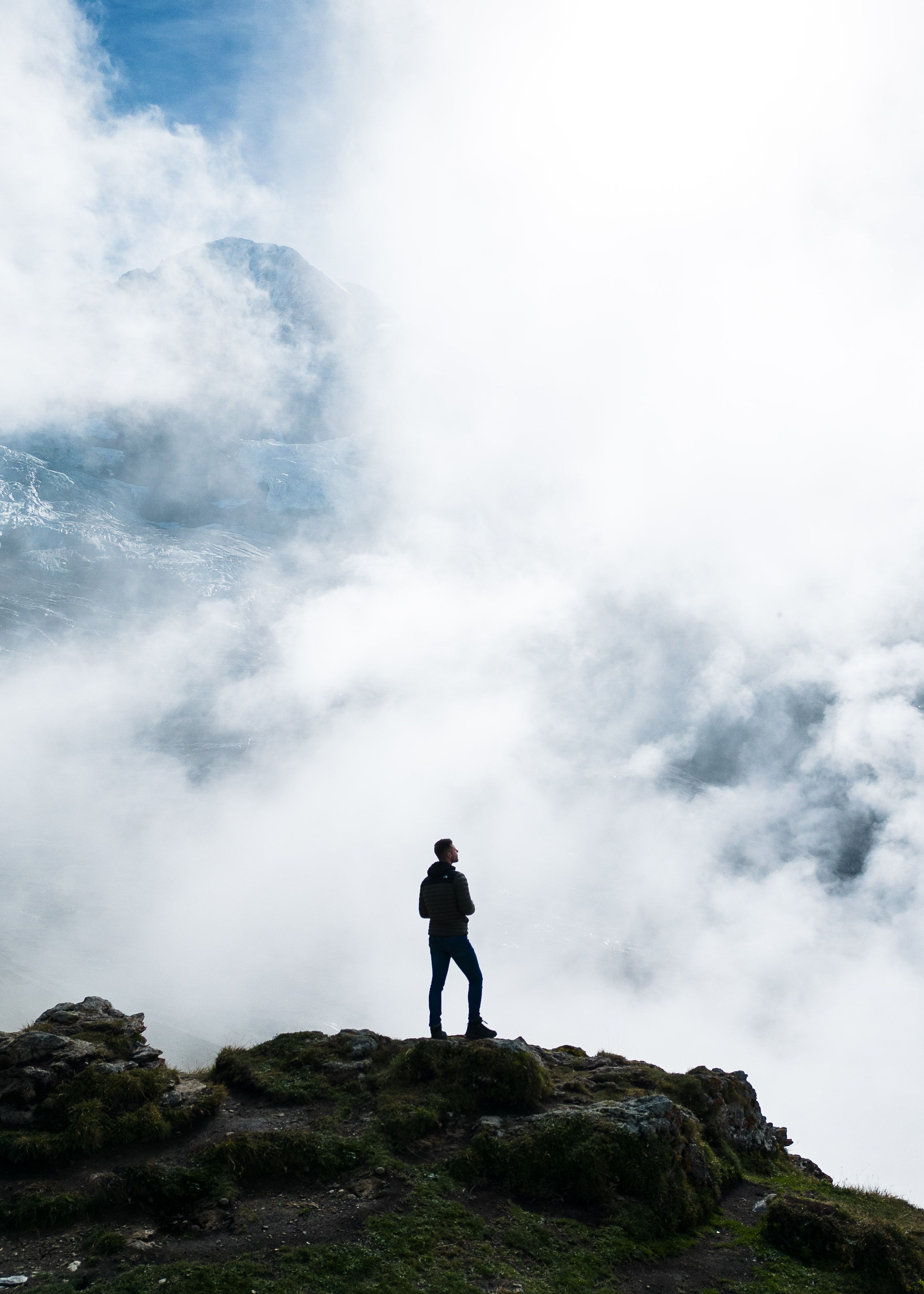 Man Standing on Rocks under Clouds · Free Stock Photo
