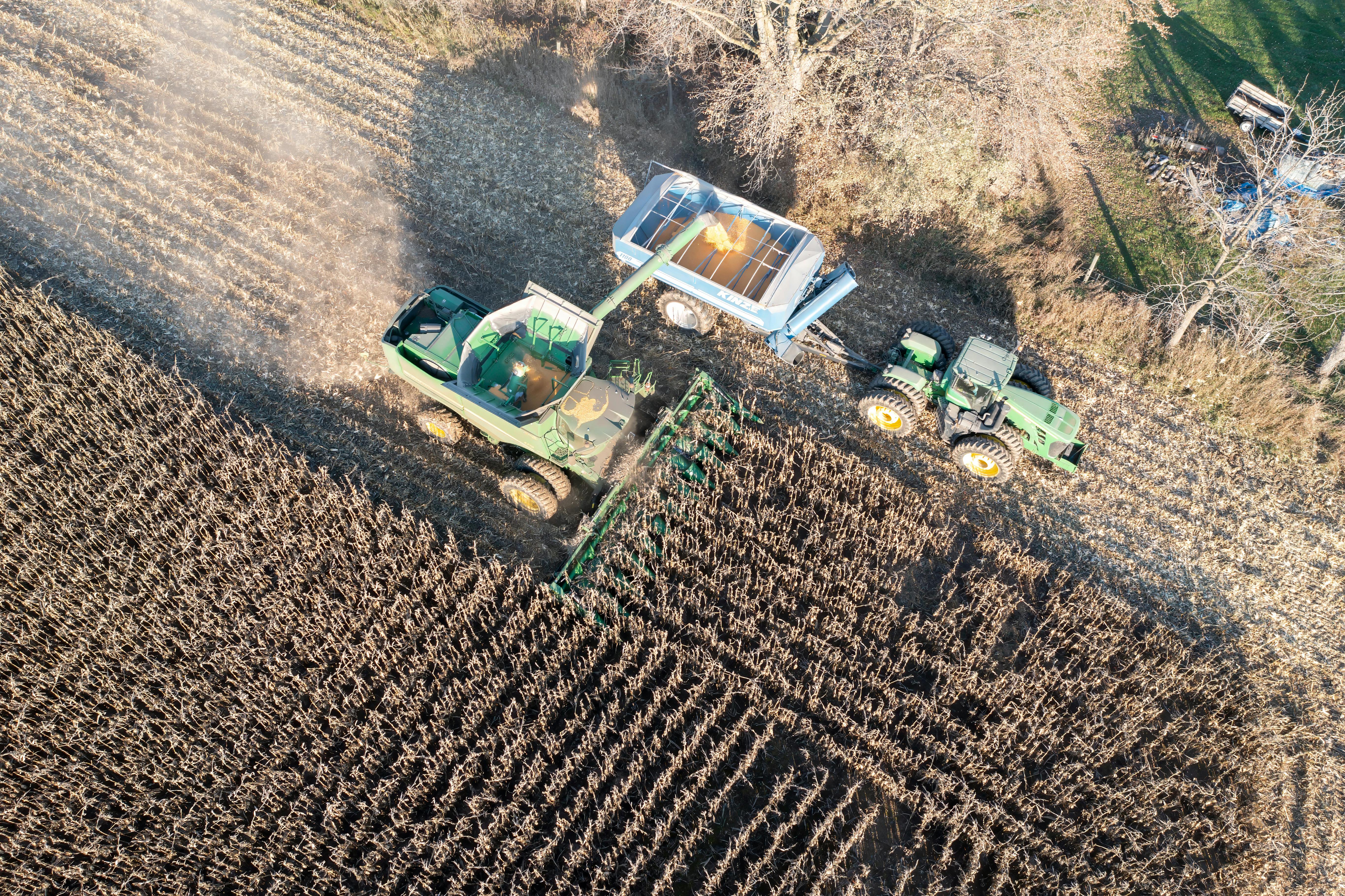 Tractor and Harvester on Field · Free Stock Photo