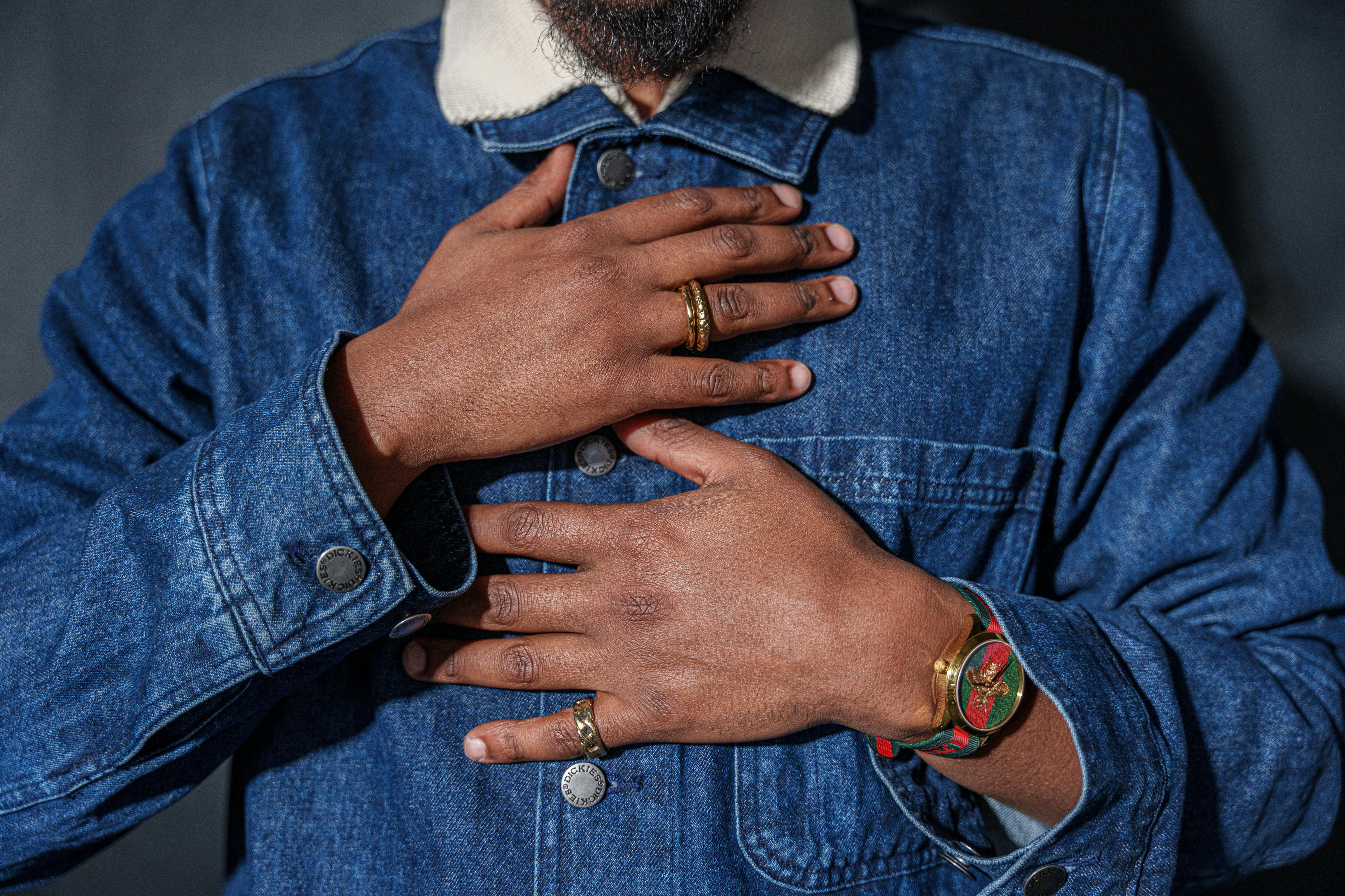 Part of a Mans Body Holding Hands on his Chest · Free Stock Photo