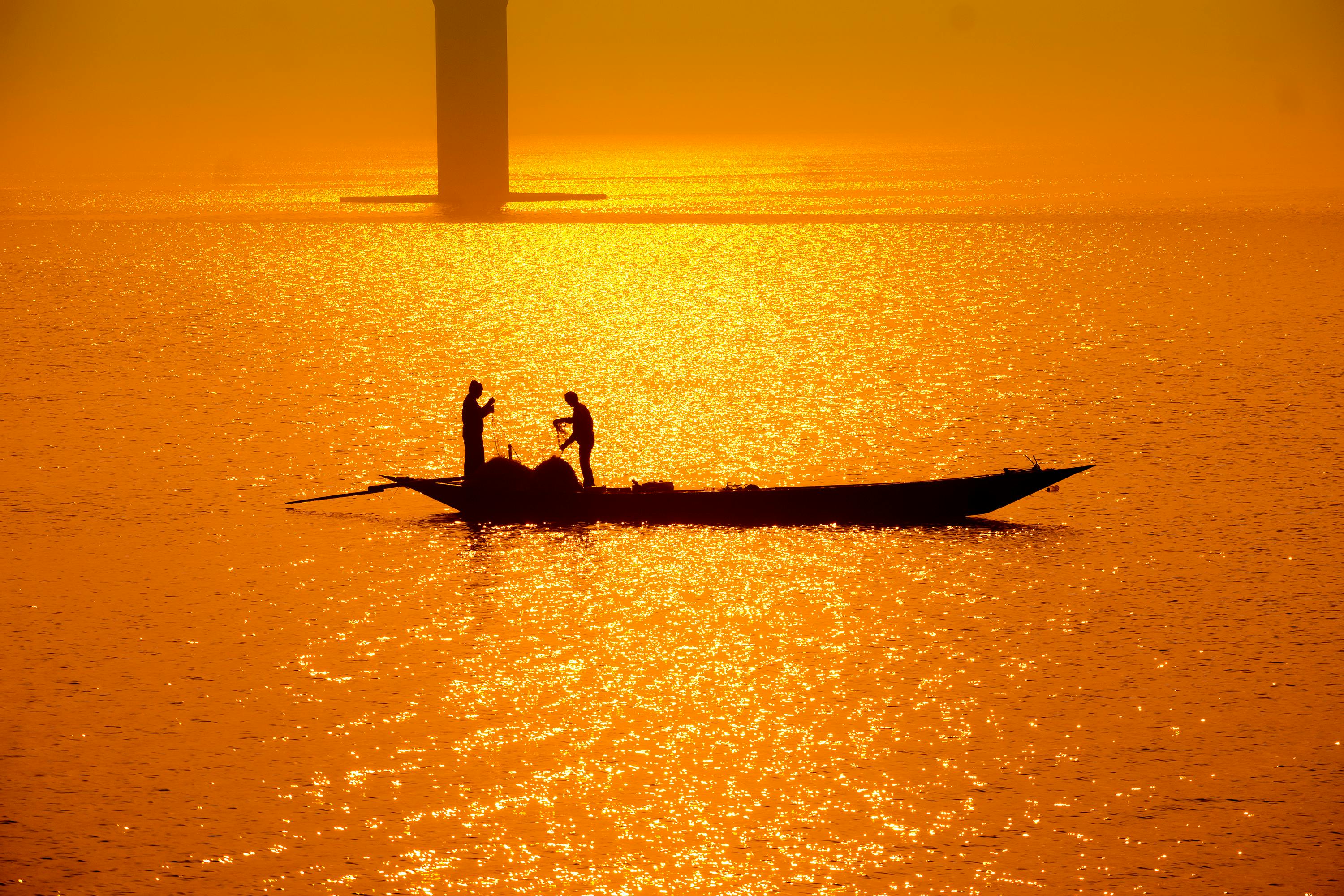 Two People on a Dhow Boat in the Sea · Free Stock Photo