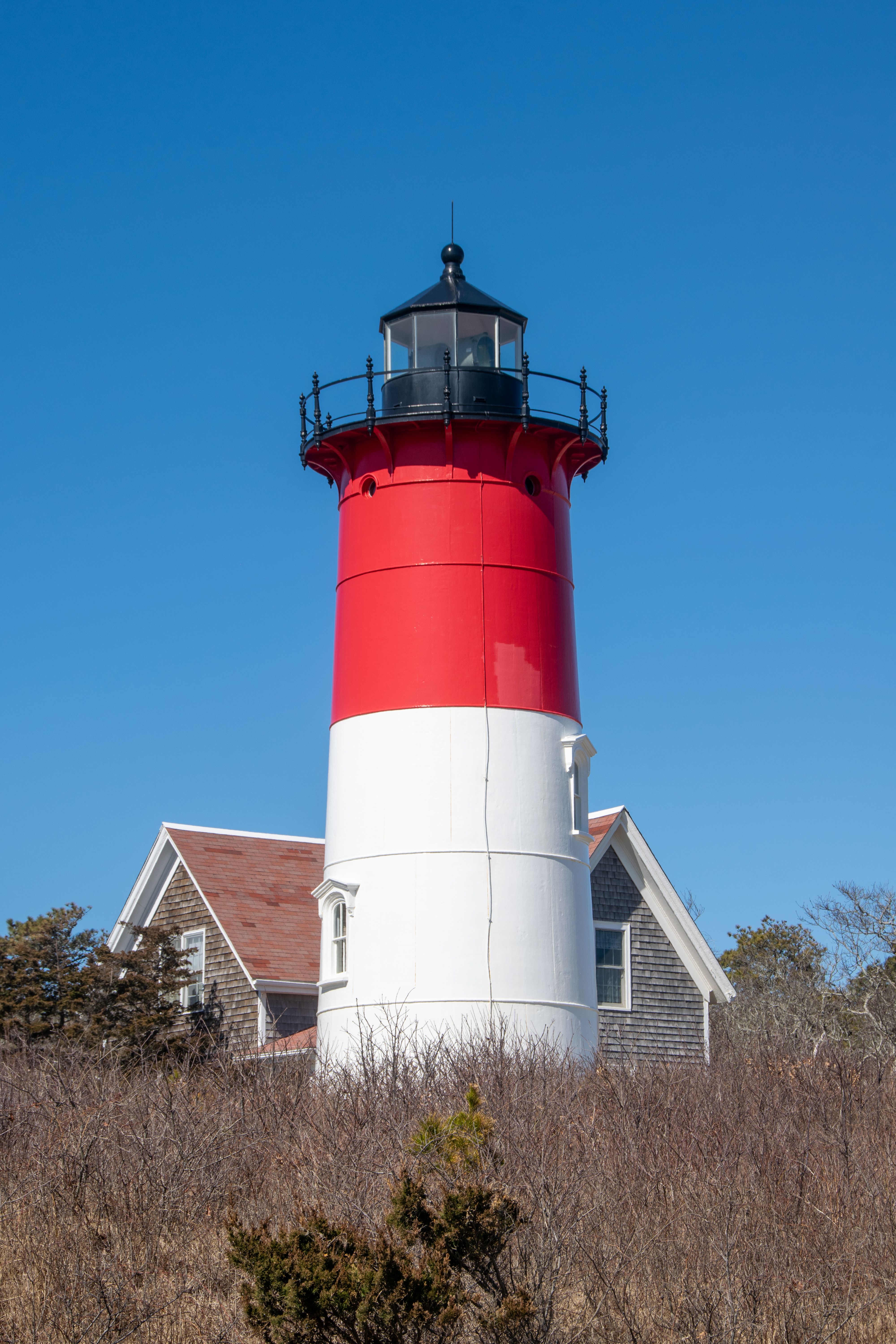White and Red Lighthouse on a Field · Free Stock Photo