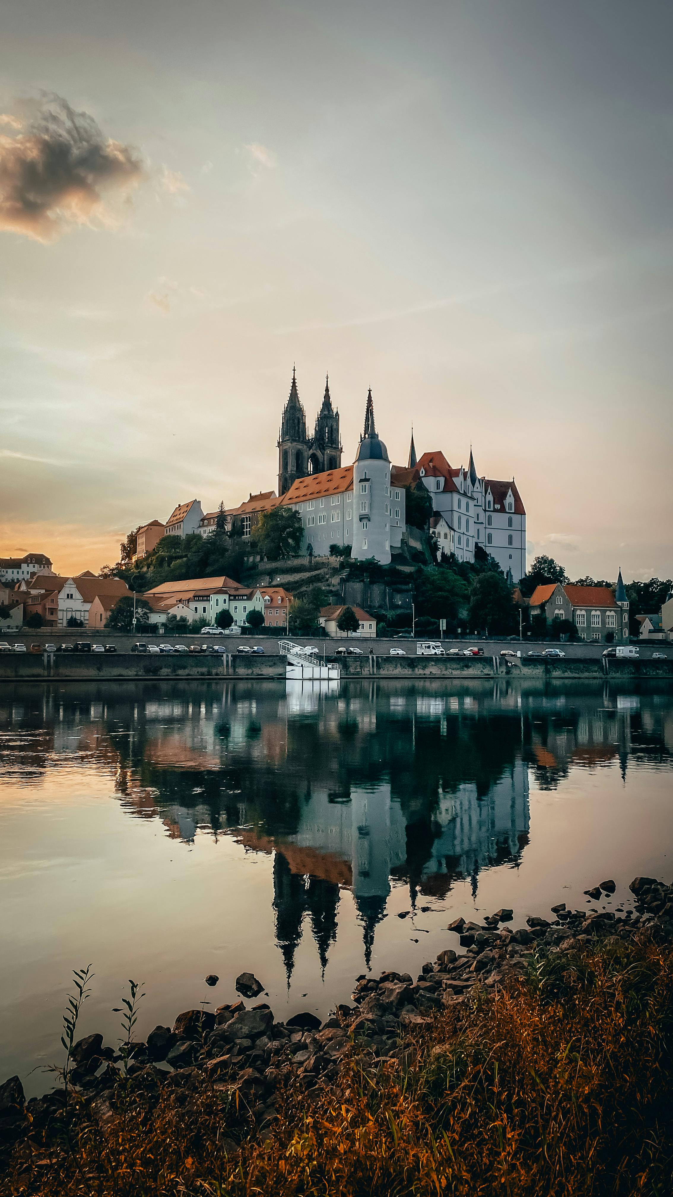 A castle on the water with a sunset · Free Stock Photo