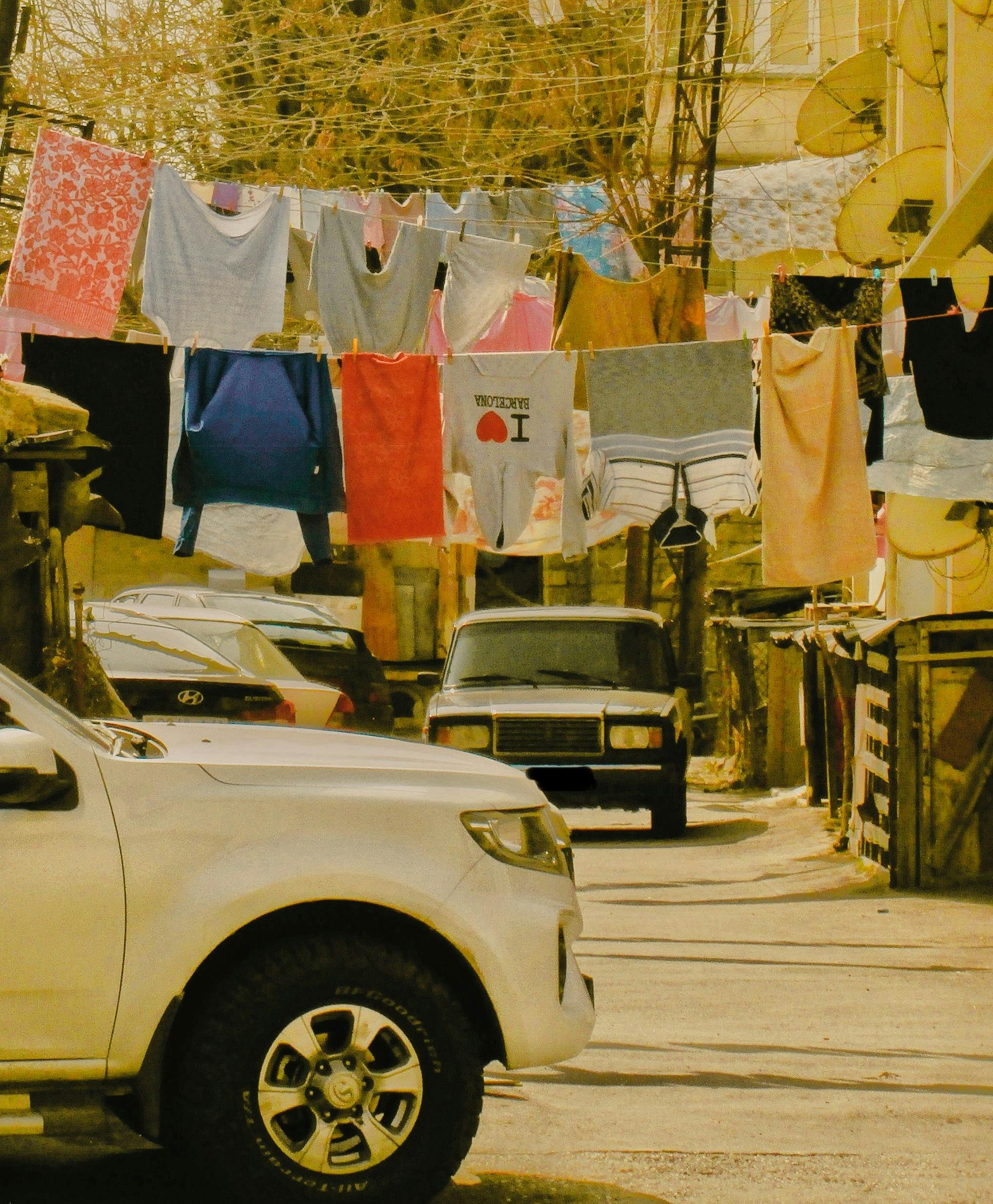 Clothes Hanging on Lines between Houses on a Narrow Street · Free Stock ...
