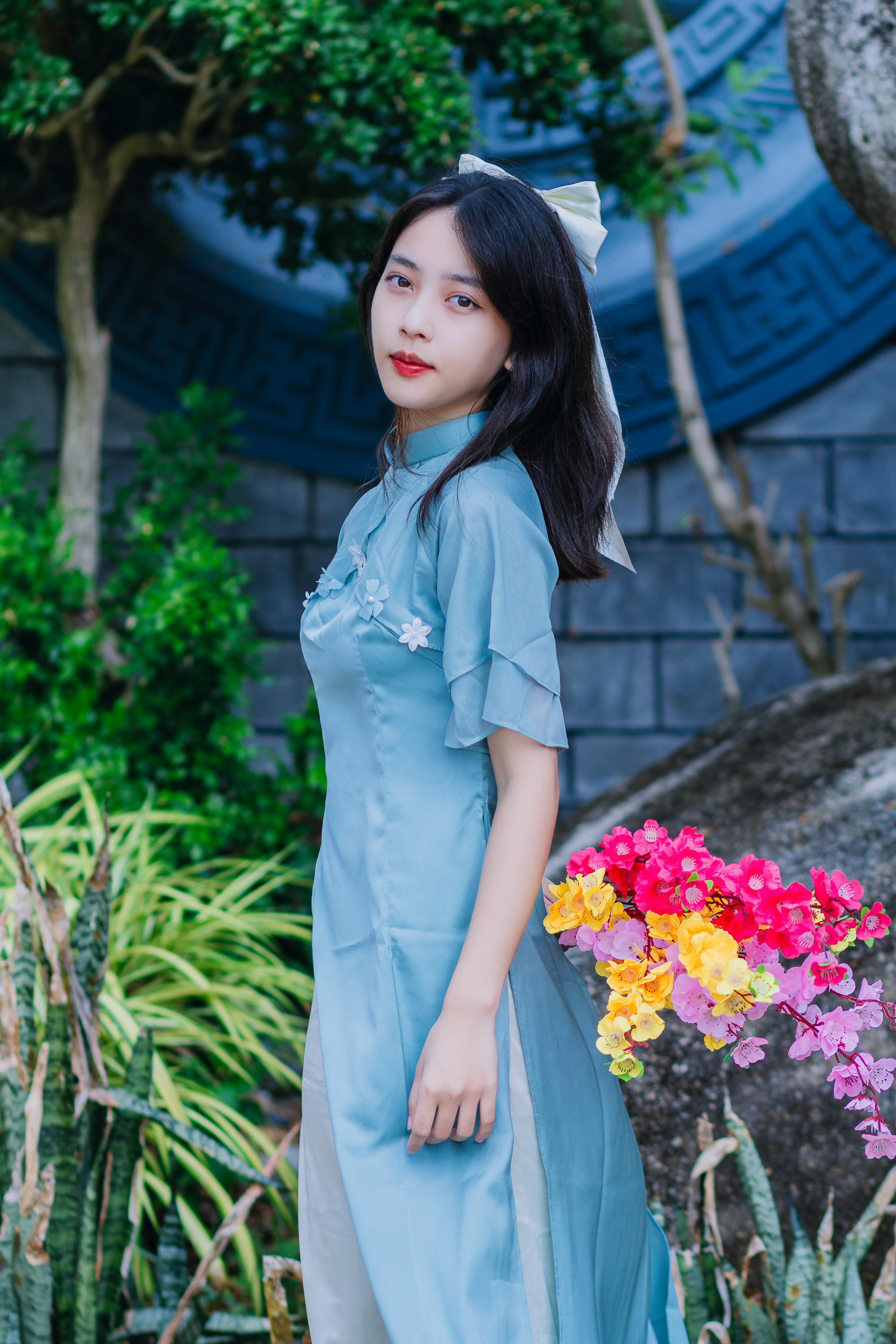 Woman in Traditional Clothing Holding Flowers · Free Stock Photo