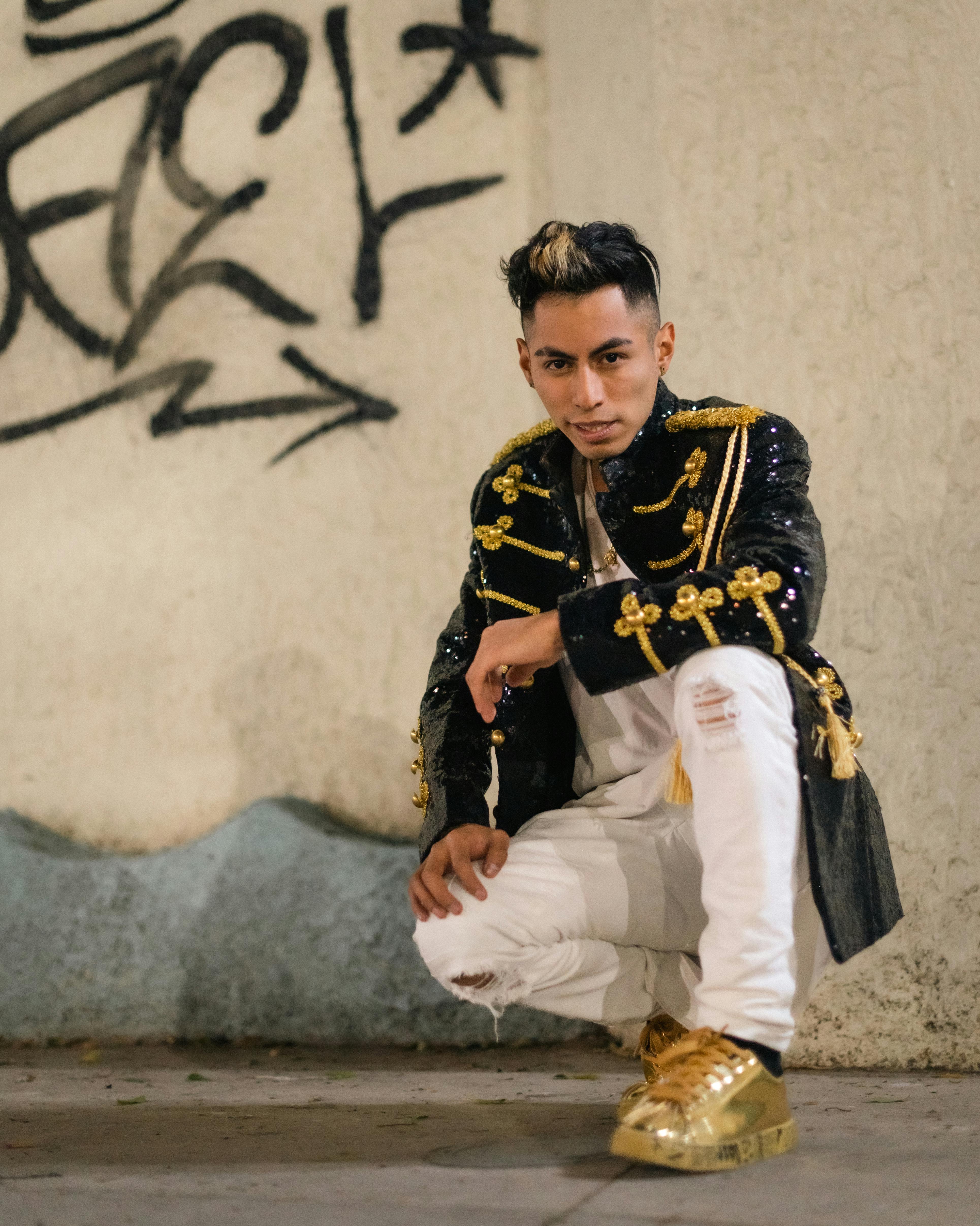 Man Crouching in front of Wall · Free Stock Photo