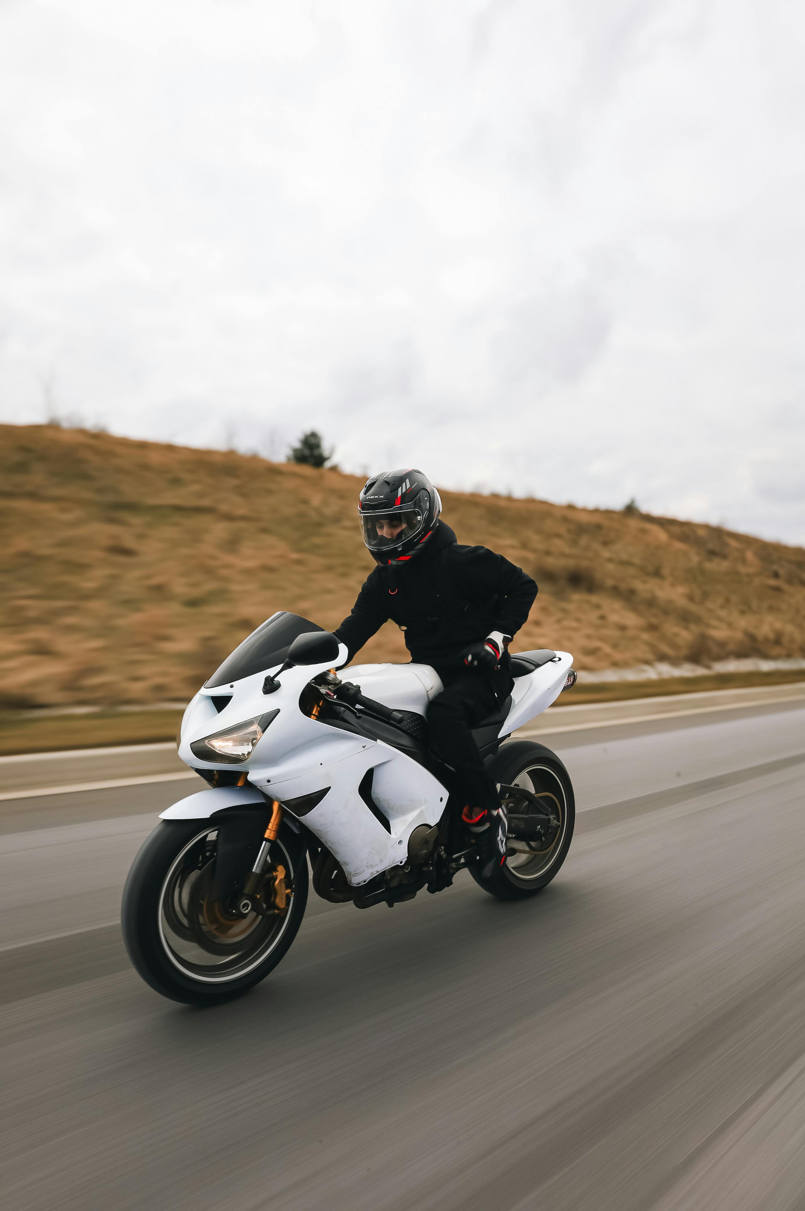 Person Riding a White Motorbike · Free Stock Photo