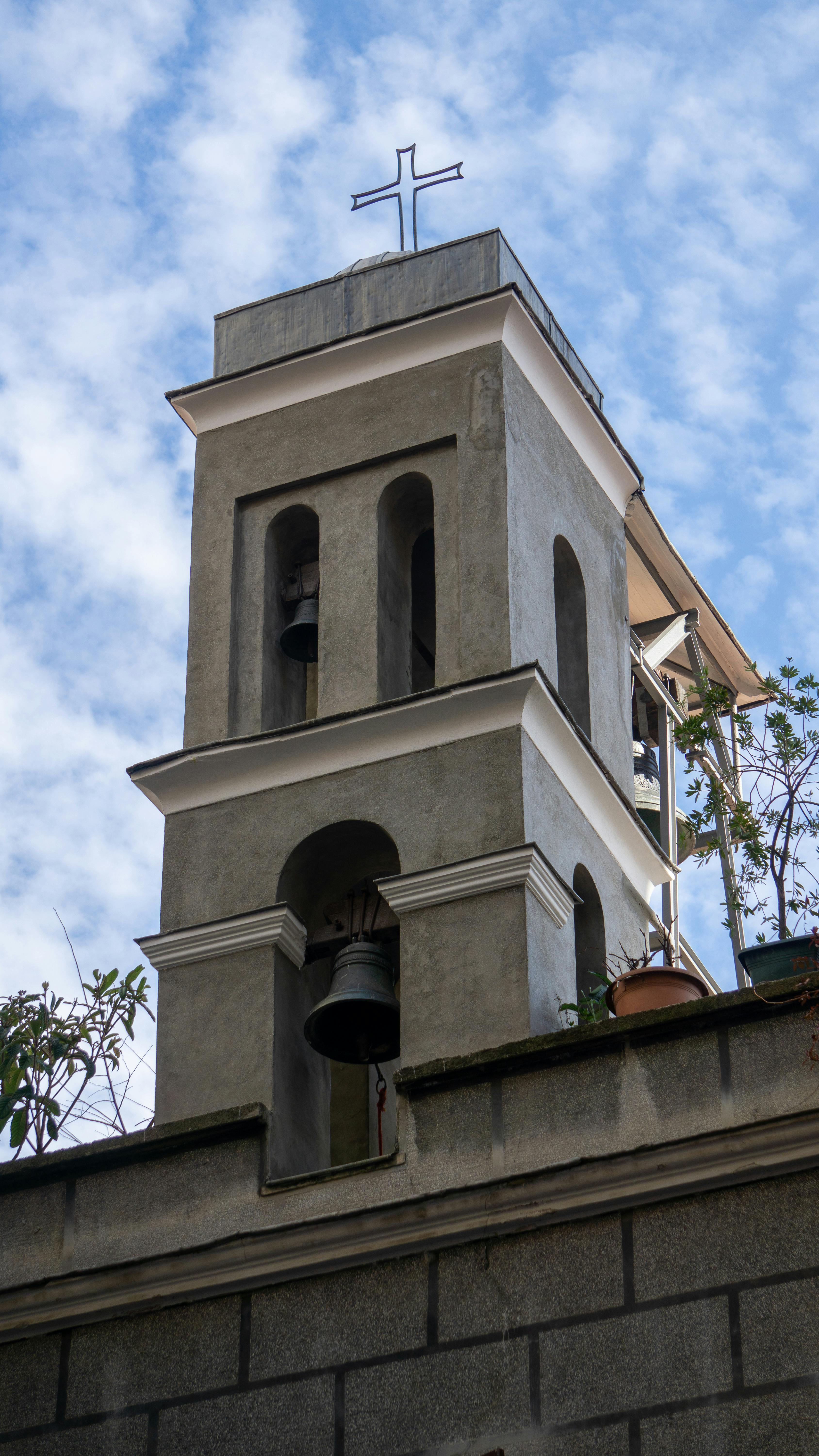 A bell tower with a cross on top · Free Stock Photo