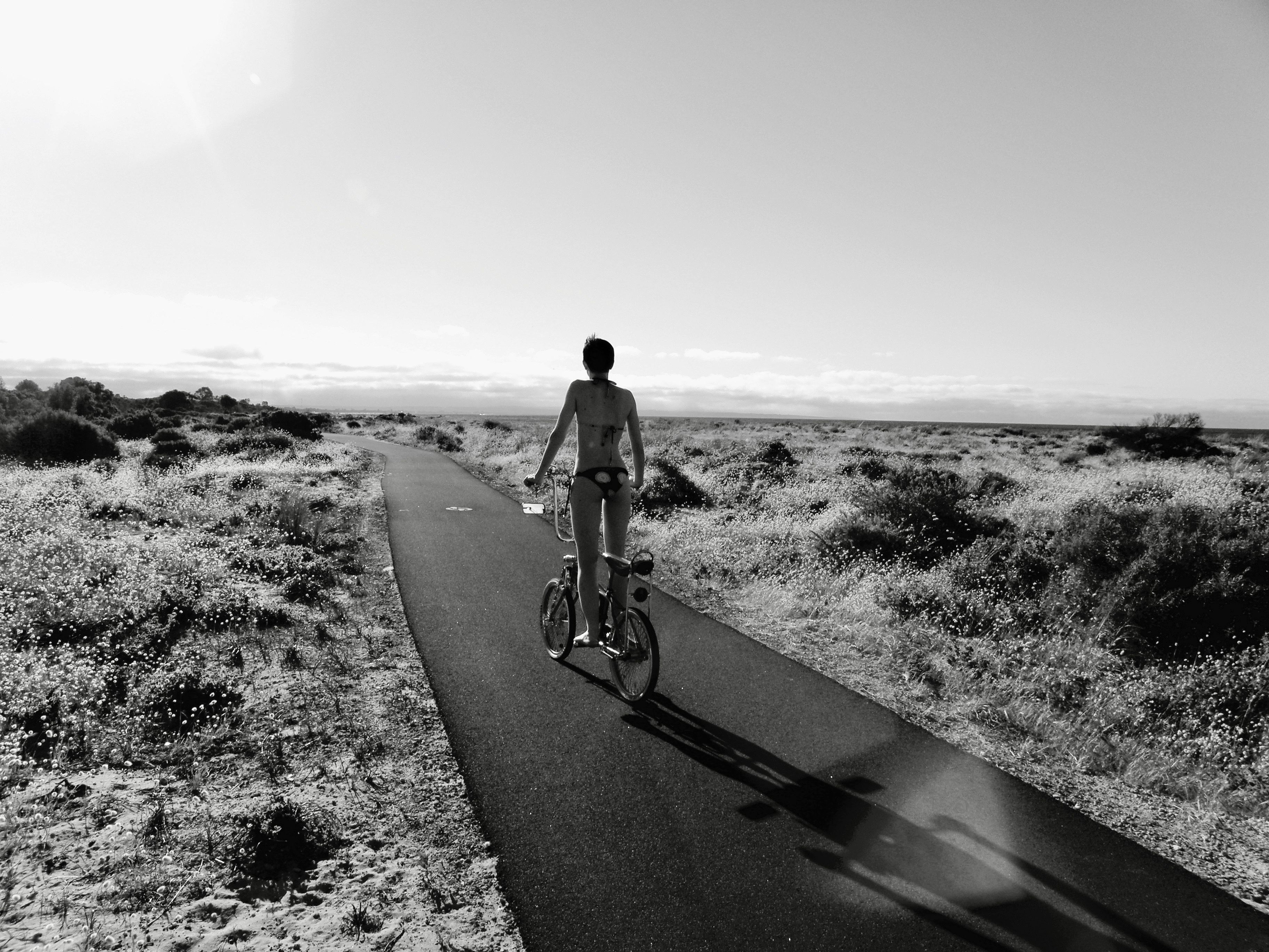 A person riding a bike on a path · Free Stock Photo