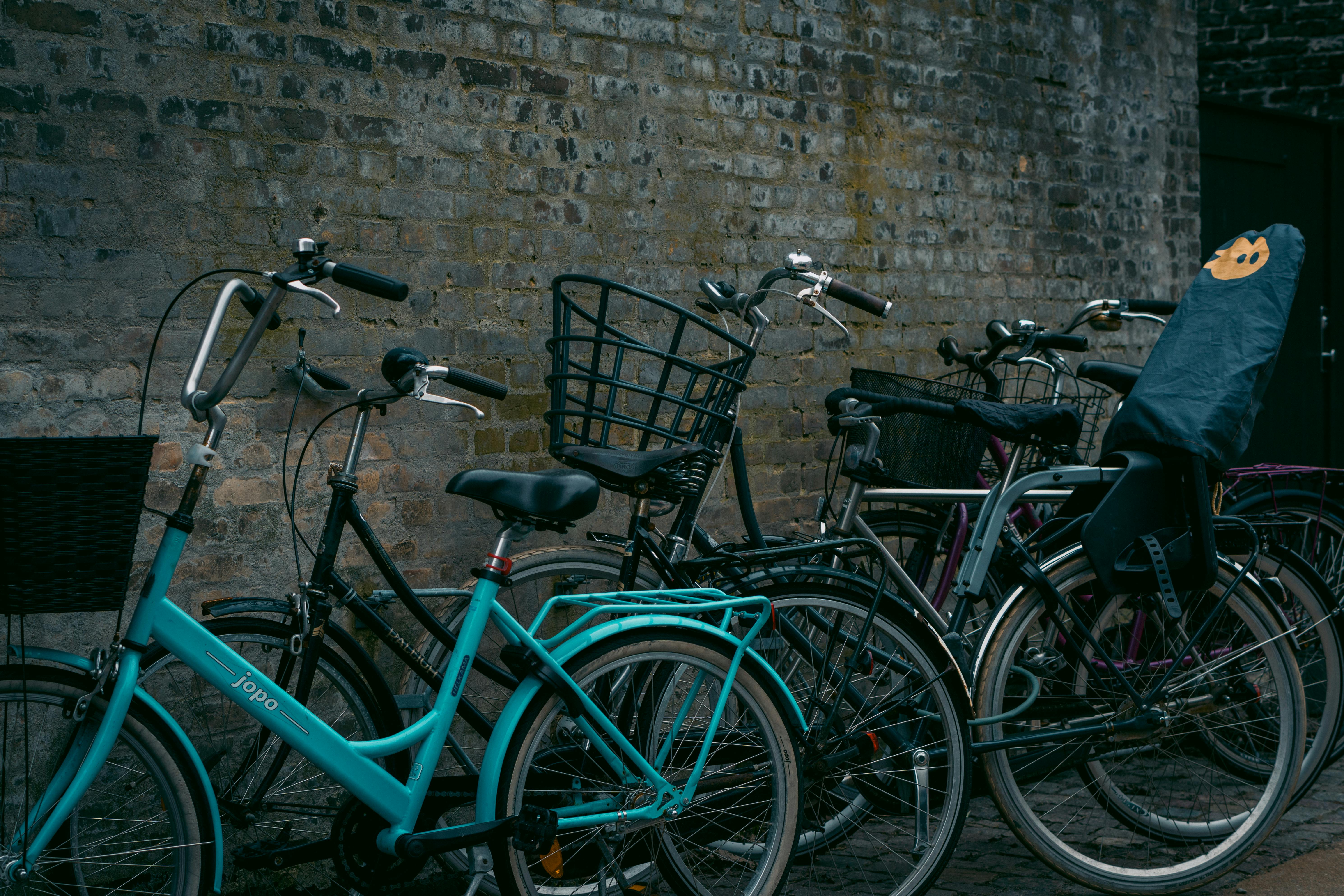 Bicycles by Stone Building Wall · Free Stock Photo